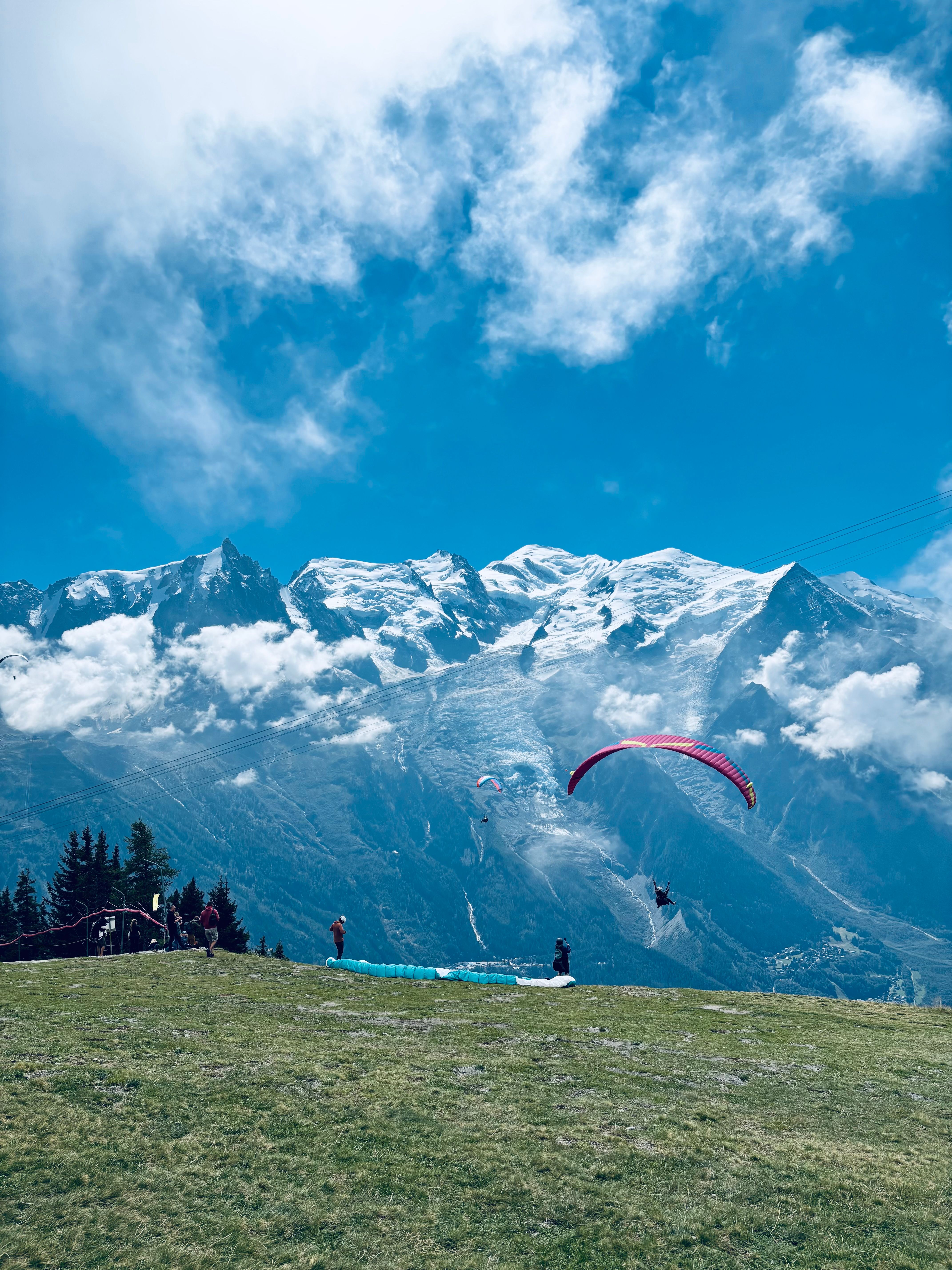 Paraglider in Front of Snow-Capped Mountains · Free Stock Photo