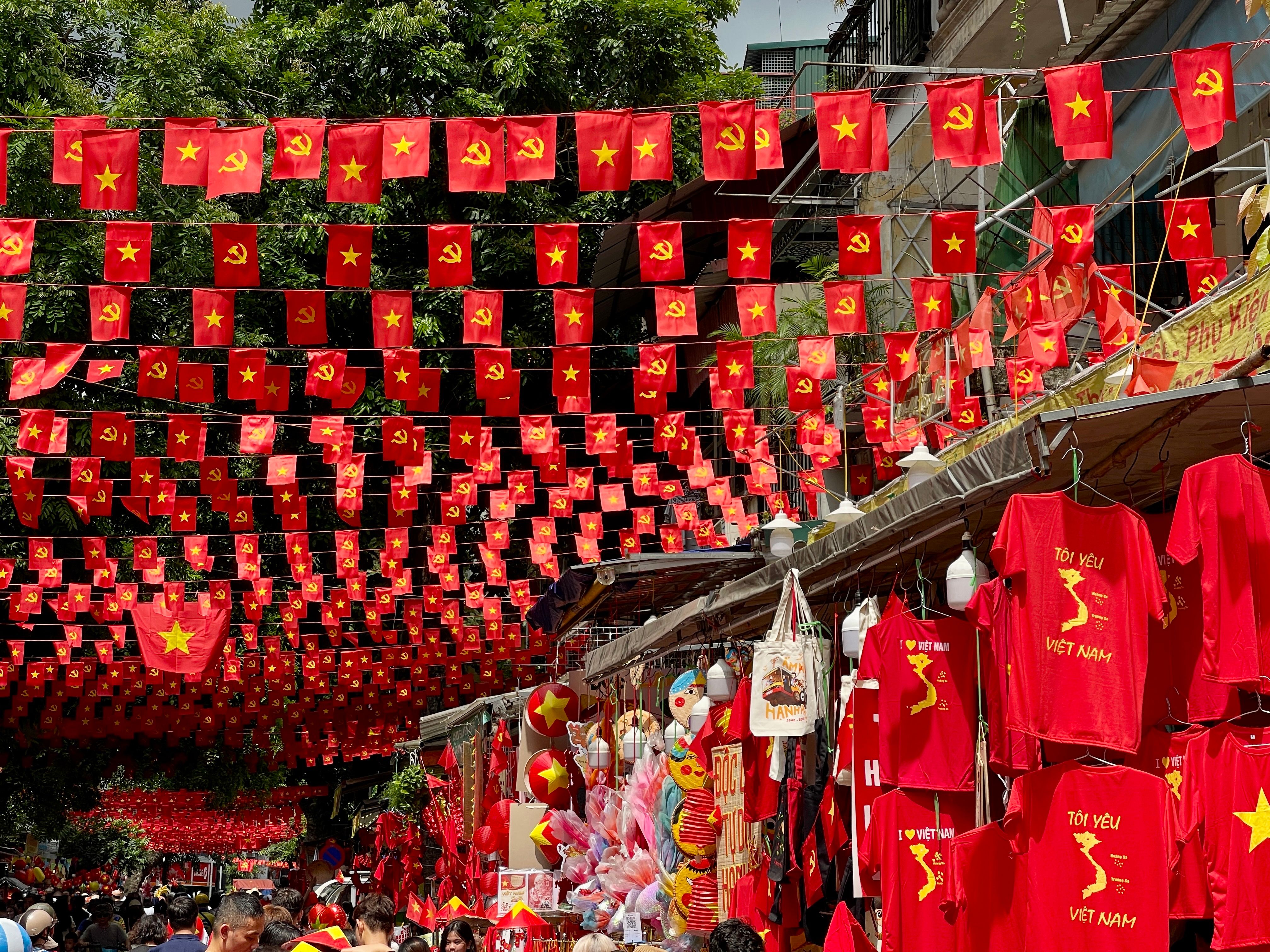 Vietnam Street Market with Red Flags and Merch · Free Stock Photo