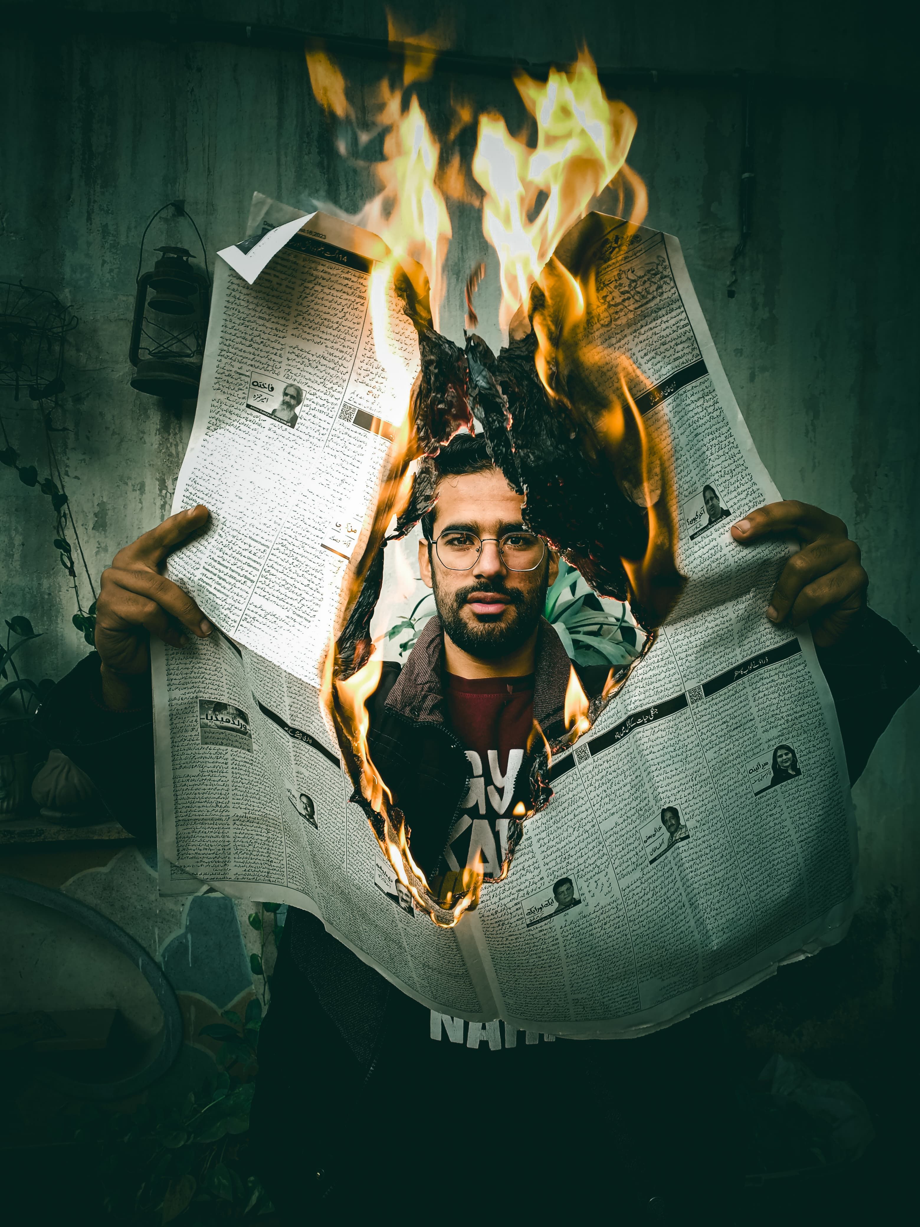 Dramatic Portrait with Burning Newspaper · Free Stock Photo