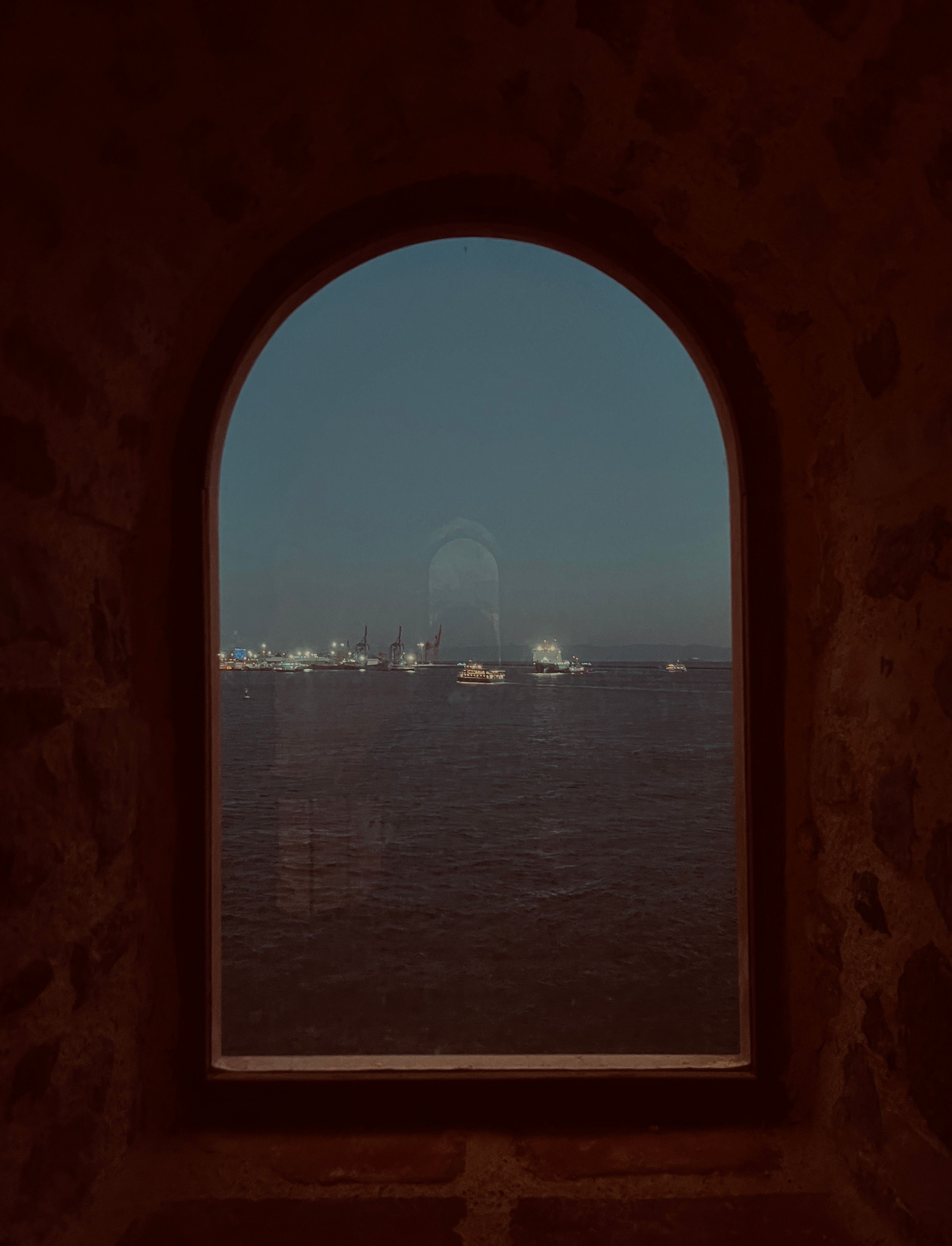 Arched Window View of Harbor at Night · Free Stock Photo