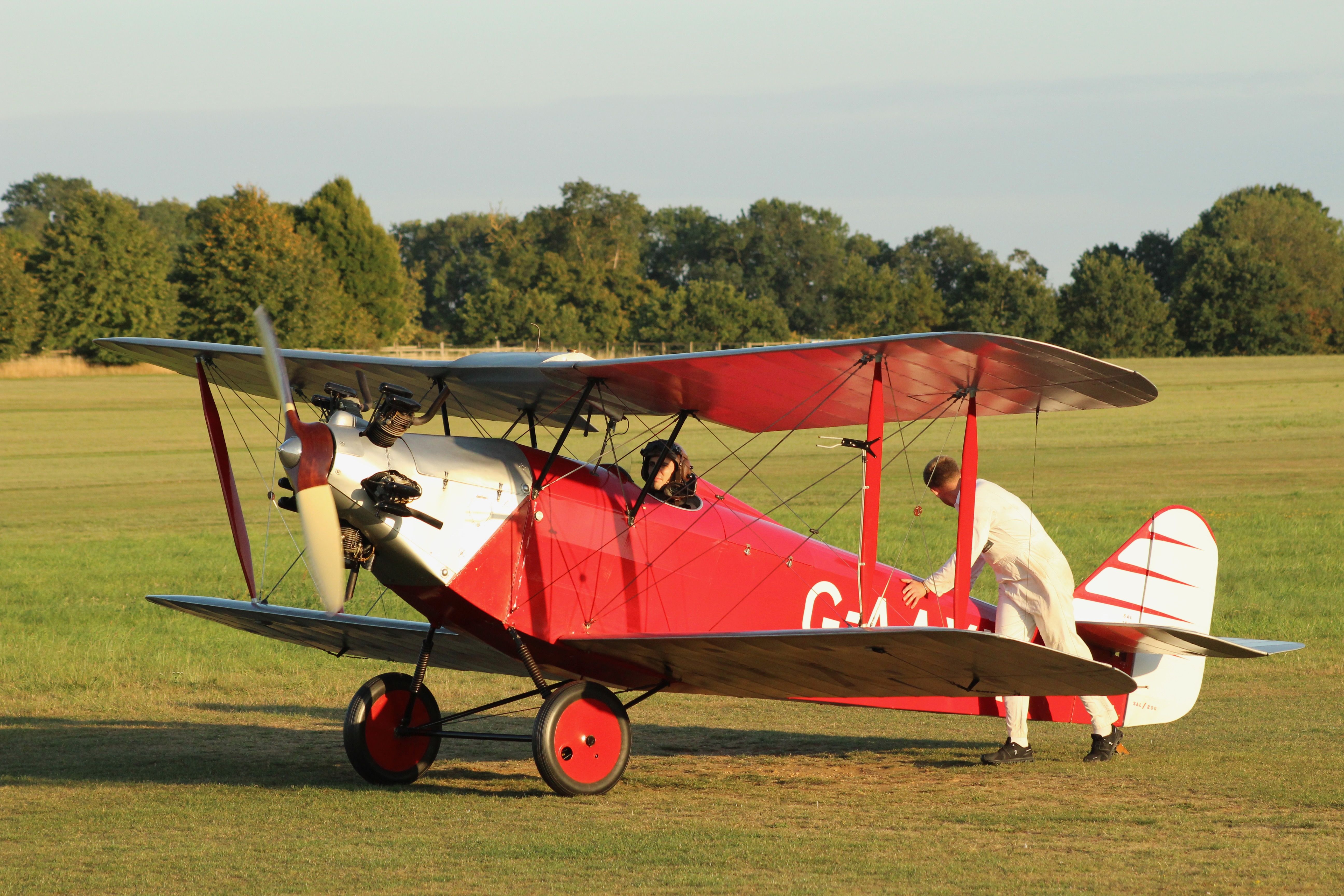 Vintage Red Biplane with Pilot and Engineer · Free Stock Photo