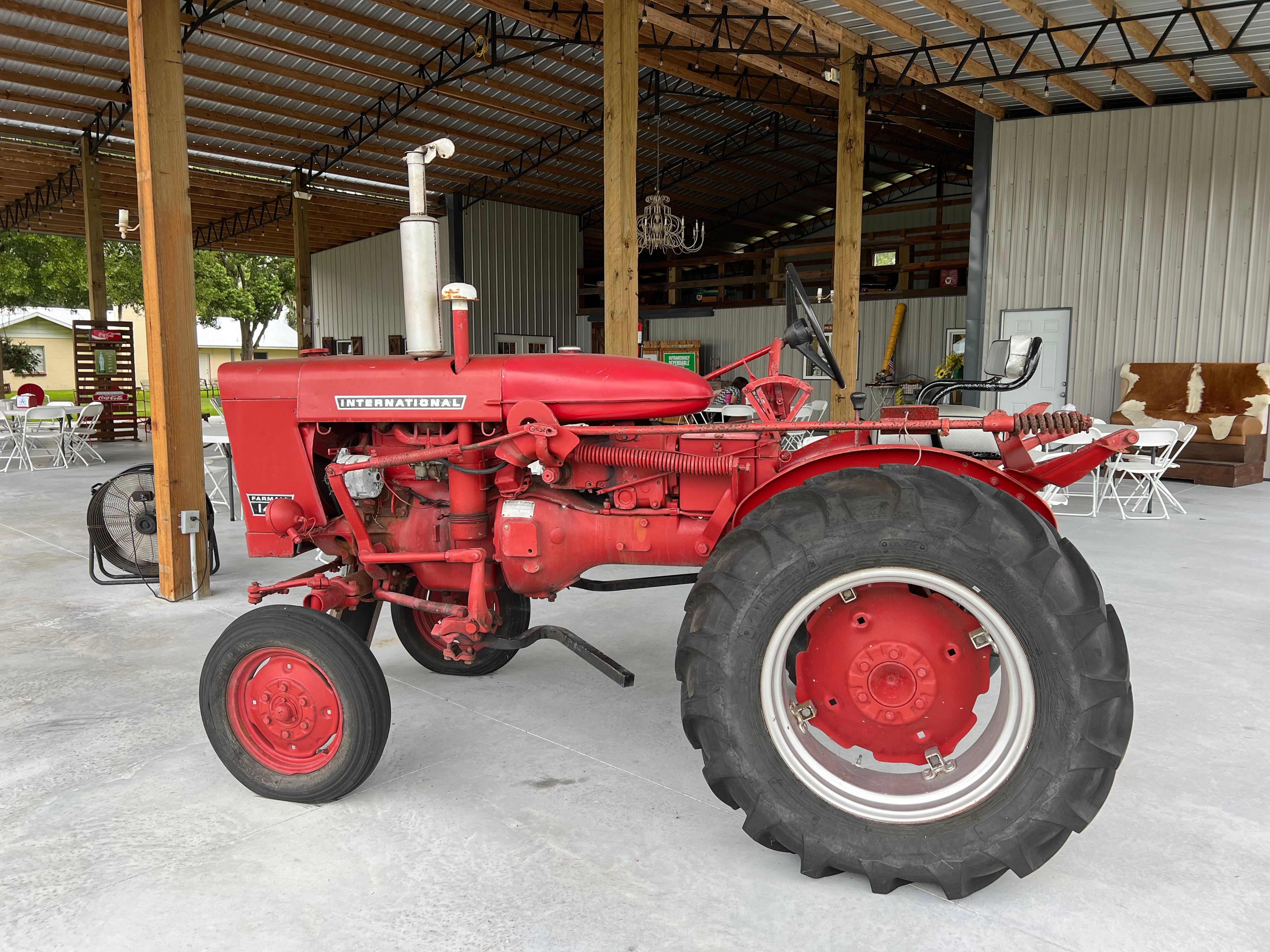 Vintage Red Farmall Tractor in Open Barn · Free Stock Photo