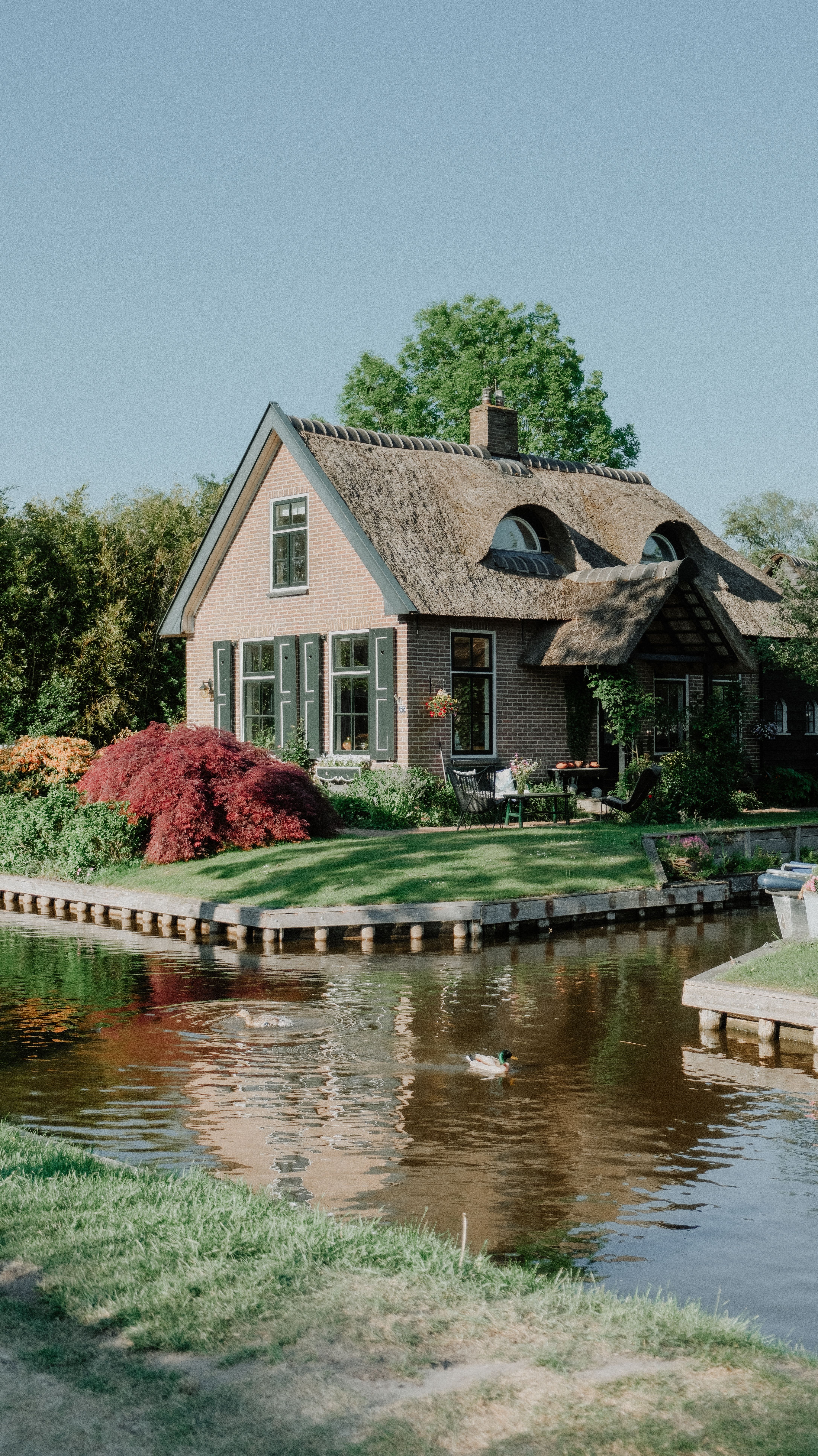 Charming European Cottage by Tranquil Canal · Free Stock Photo