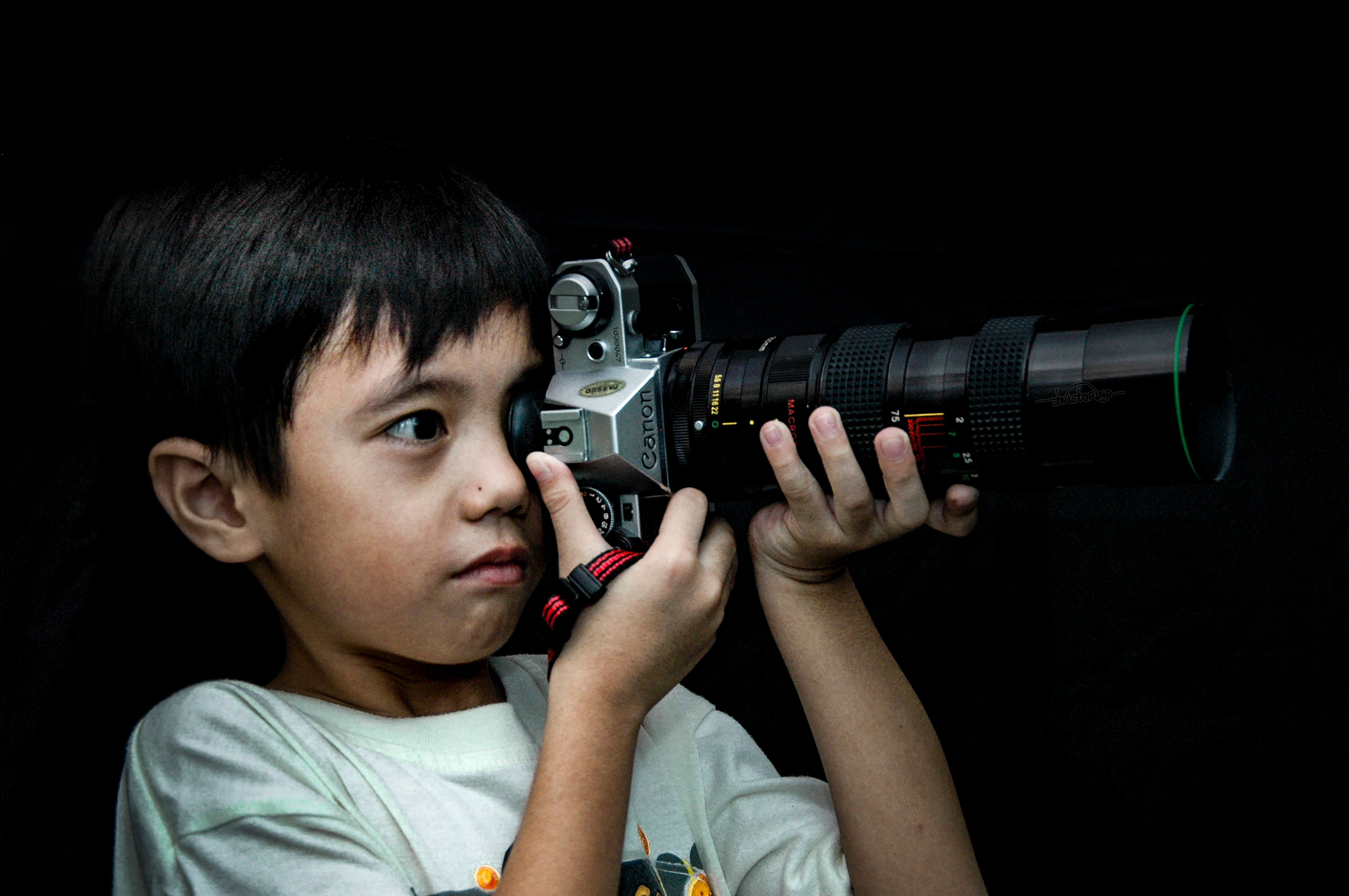 Young Child Exploring Photography with Camera · Free Stock Photo