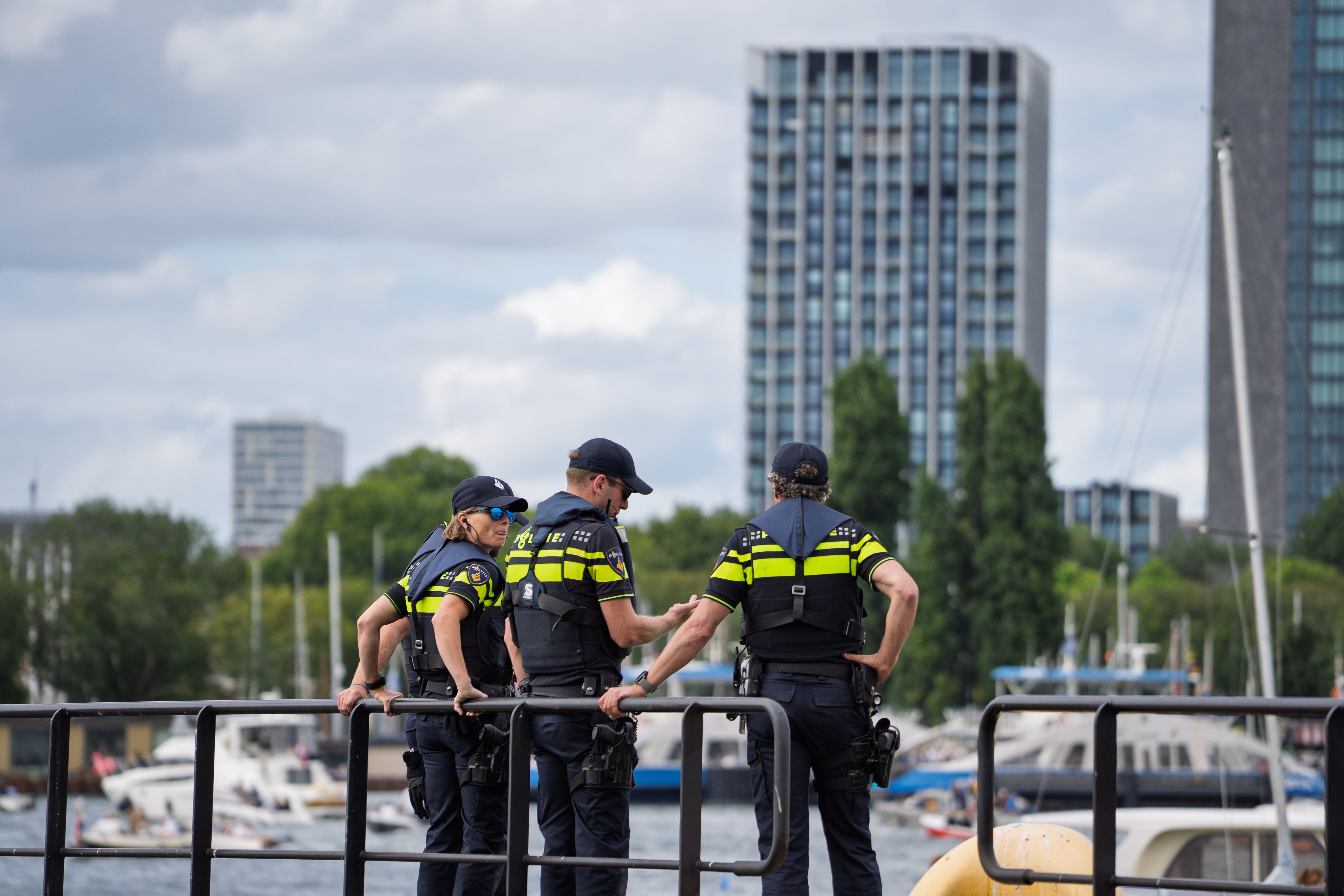 Urban Police Officers Overlooking City Waterfront · Free Stock Photo