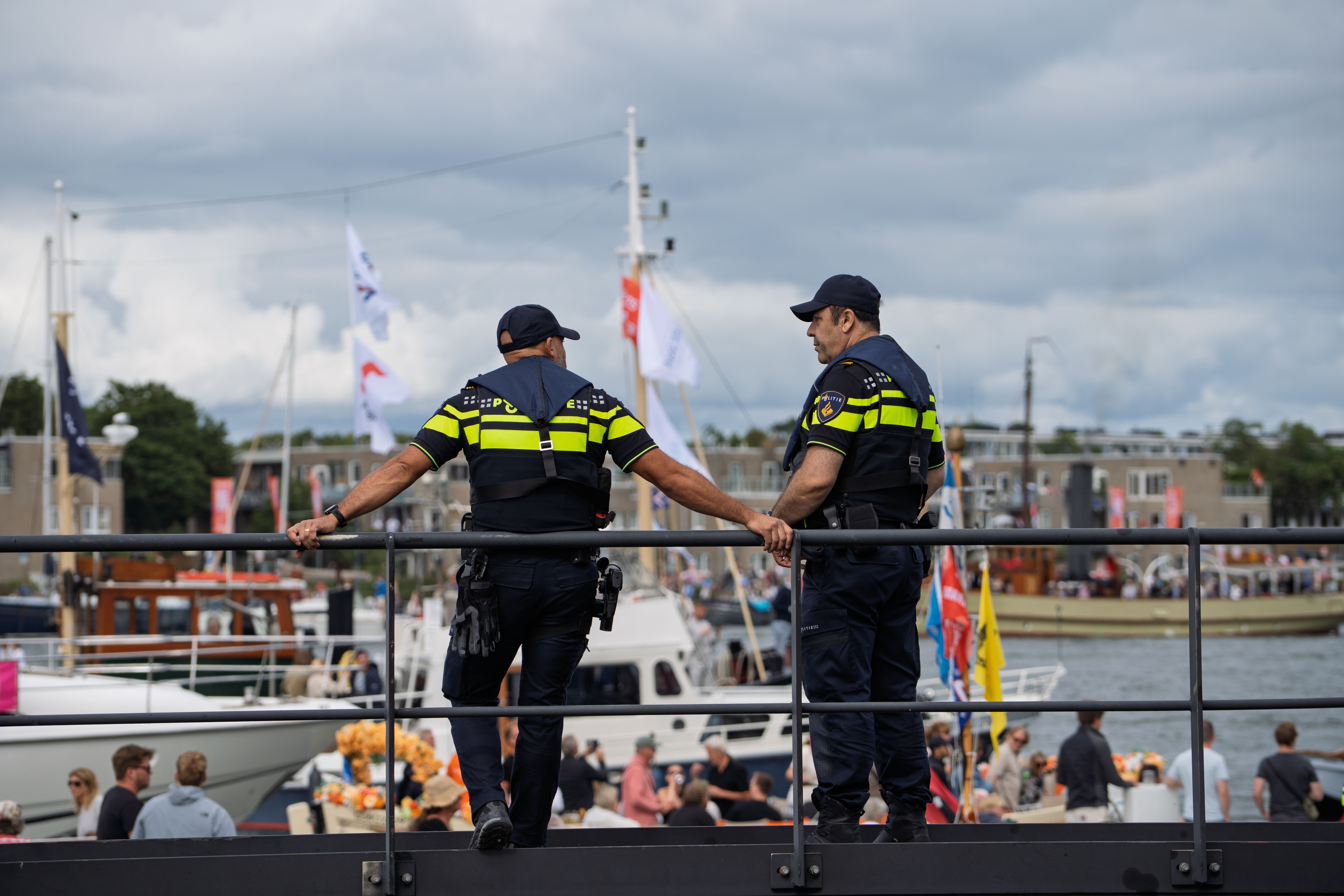Urban Police Officers Overlooking City Waterfront · Free Stock Photo