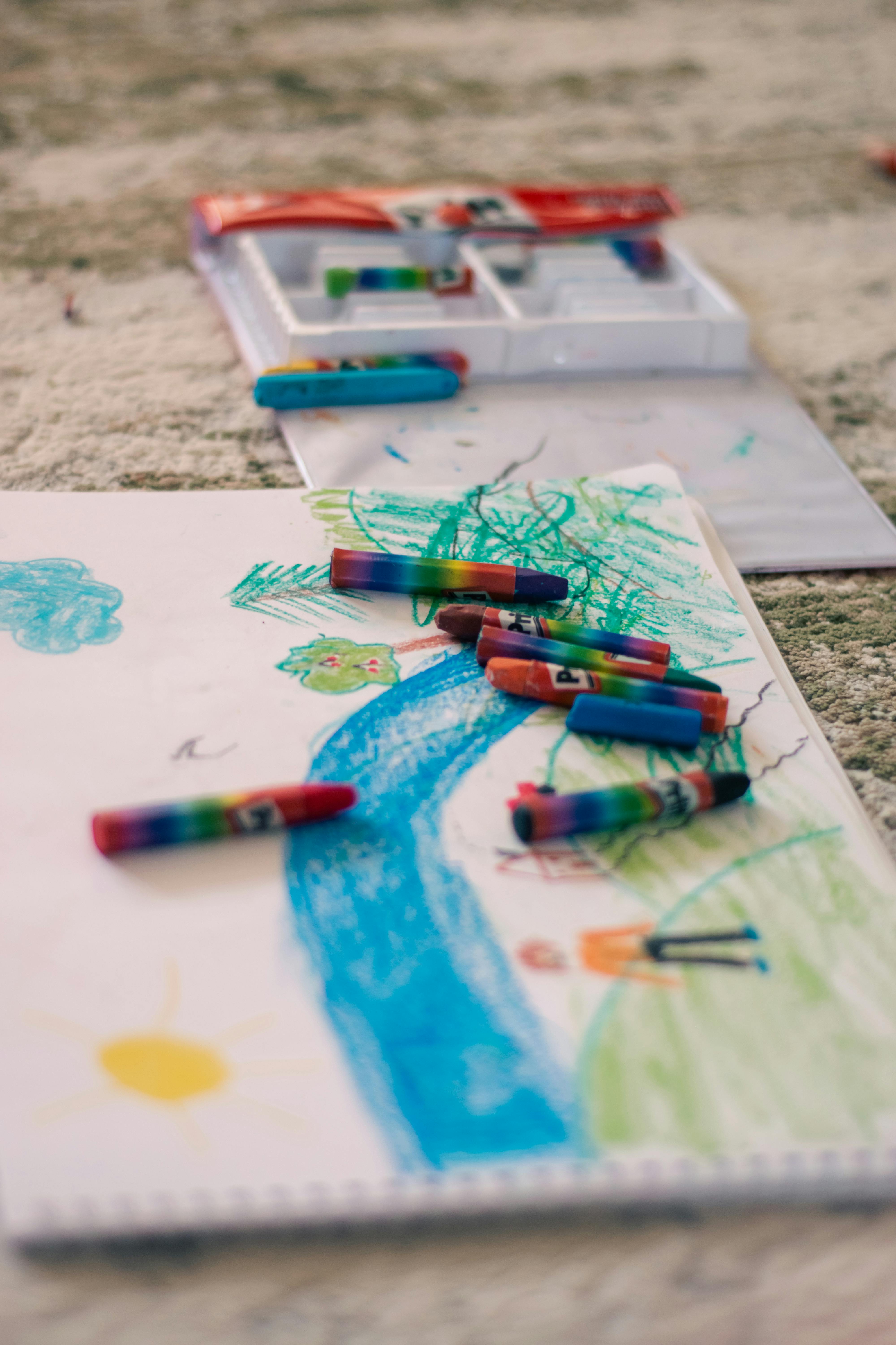 Workplace of artist with paper drafts and paint tubes · Free Stock Photo