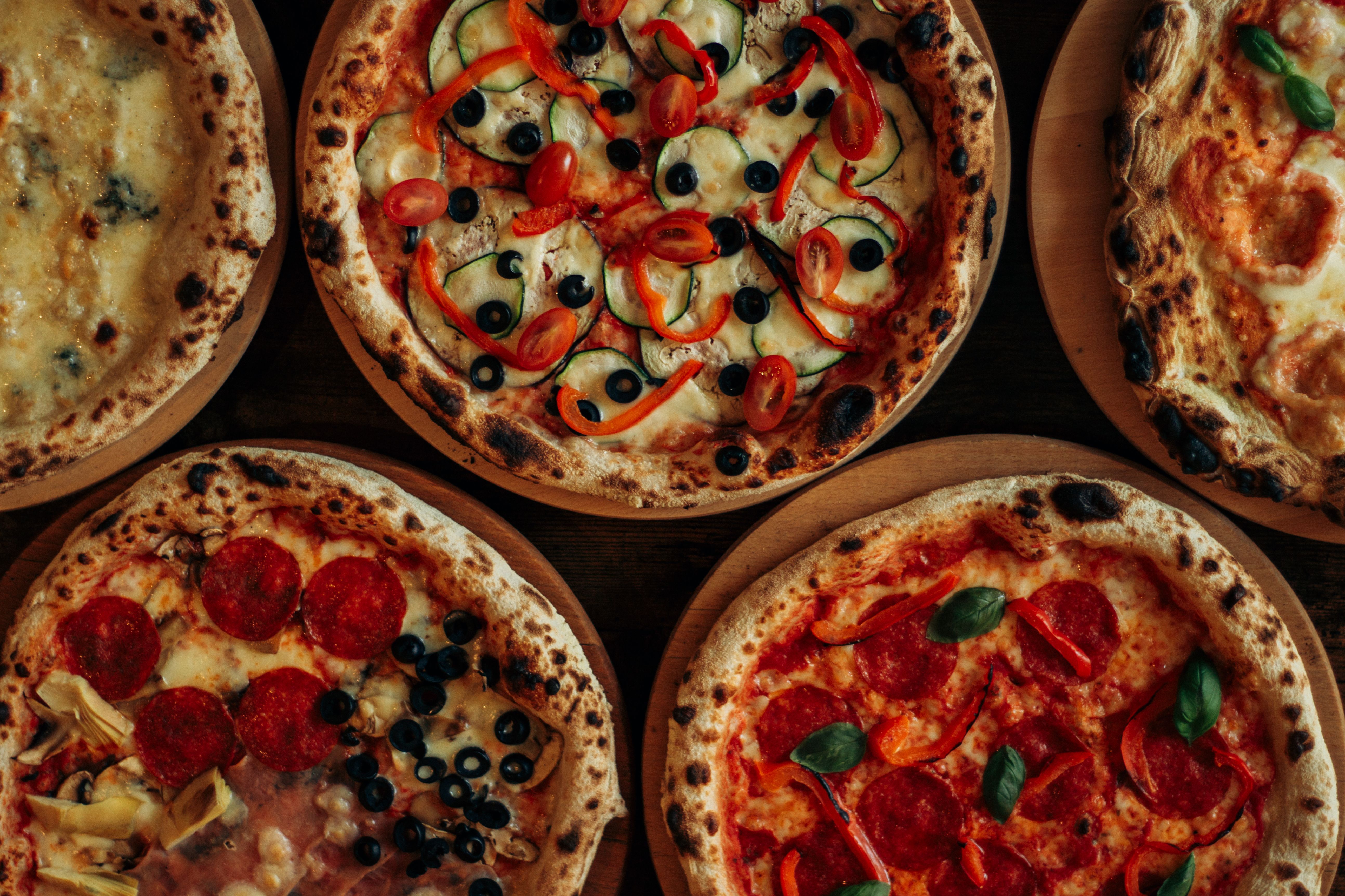 Assorted gourmet pizzas with toppings · Free Stock Photo