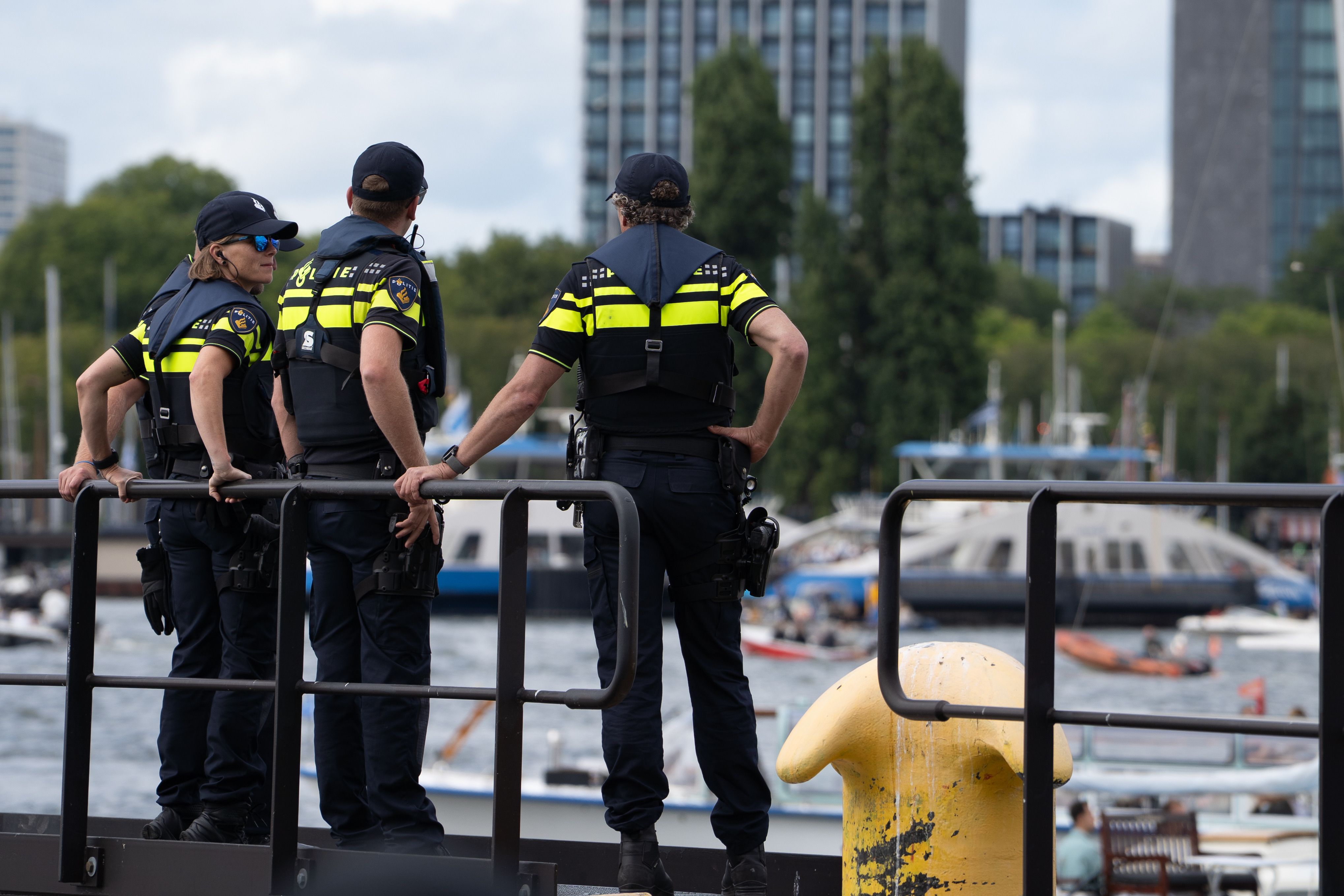 Police Officers Overlooking Waterfront Scene · Free Stock Photo
