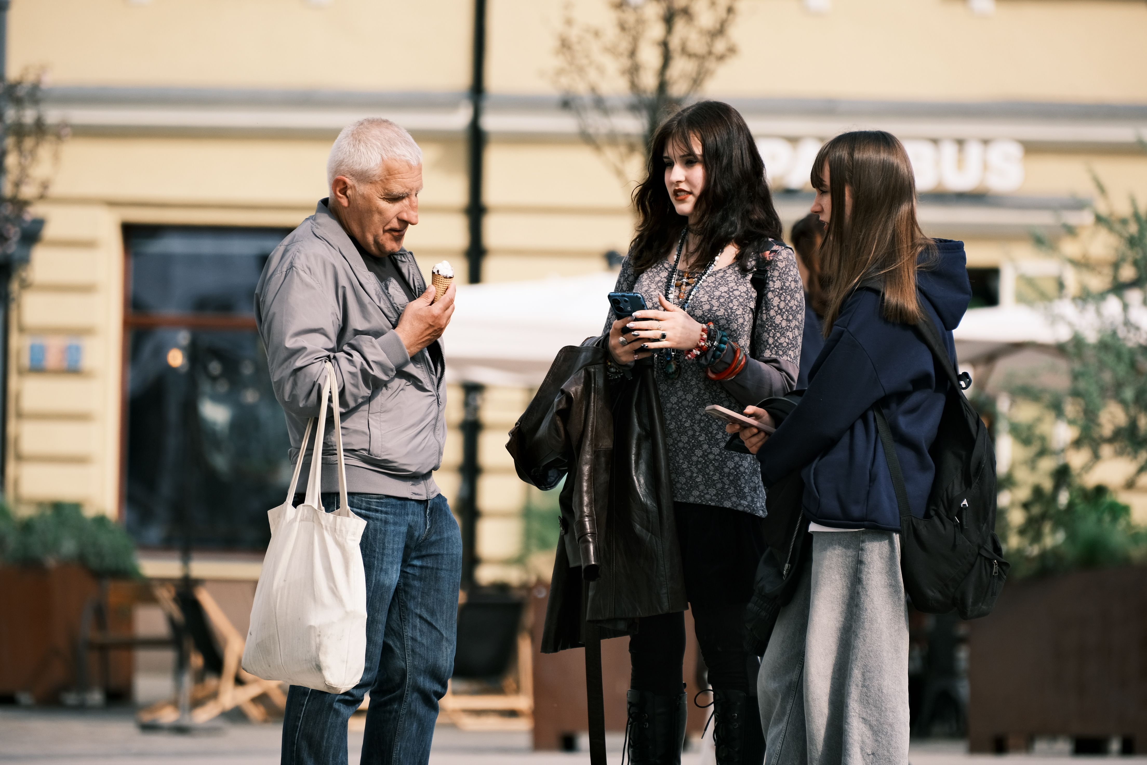 Casual Street Discussion in Urban Setting · Free Stock Photo