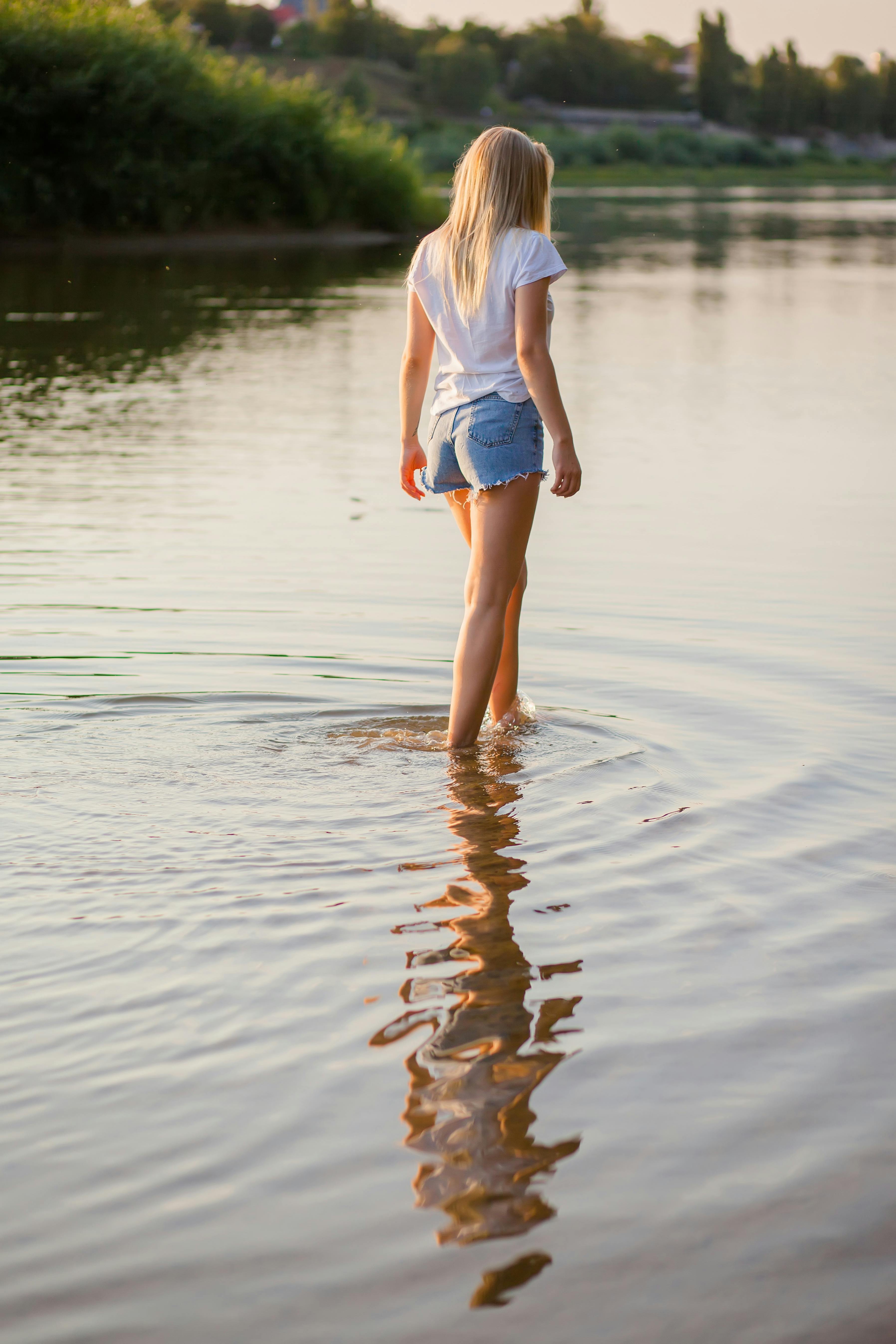 Woman Walking on Body of Water · Free Stock Photo