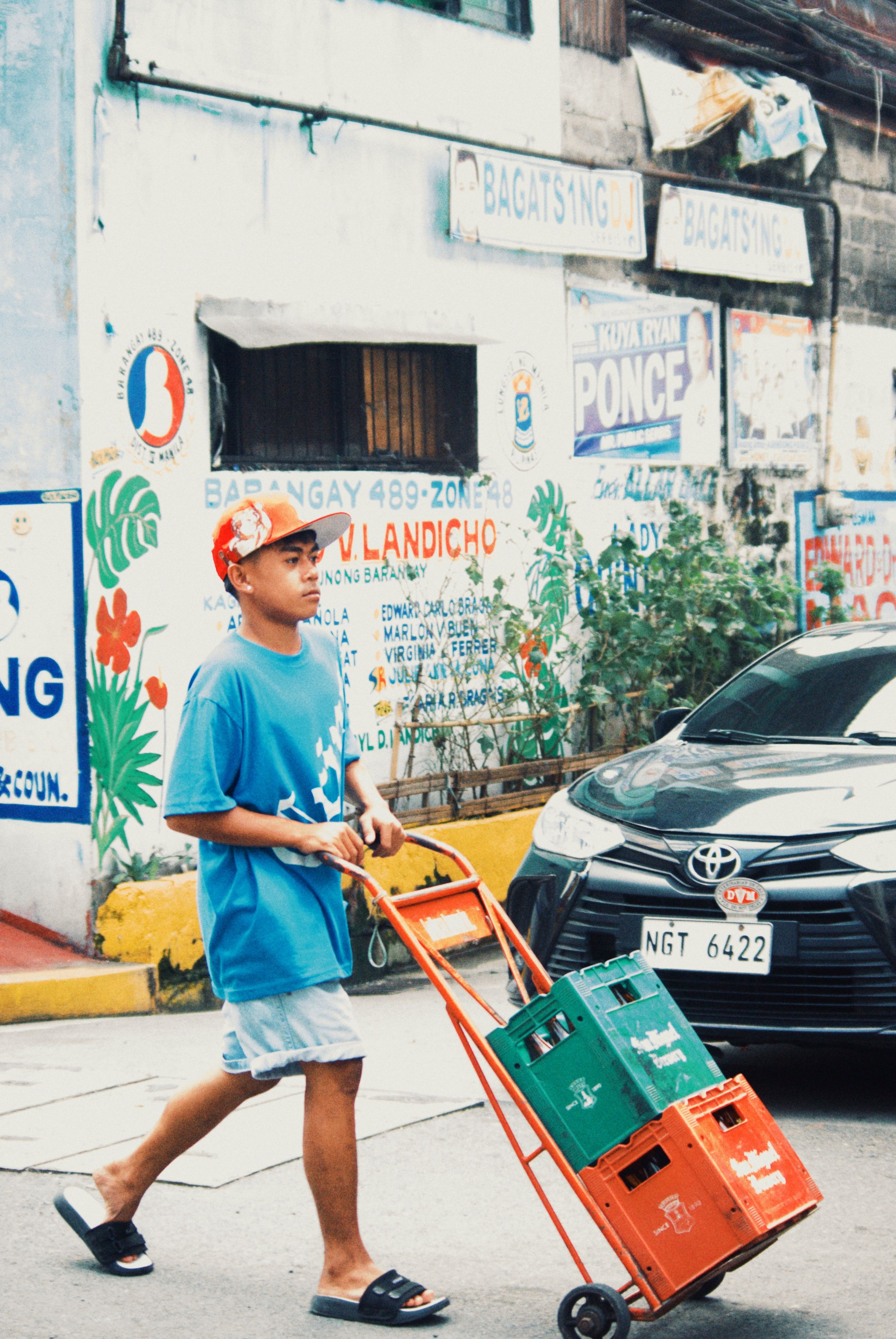 Man Pushing Cart on Busy Urban Street · Free Stock Photo