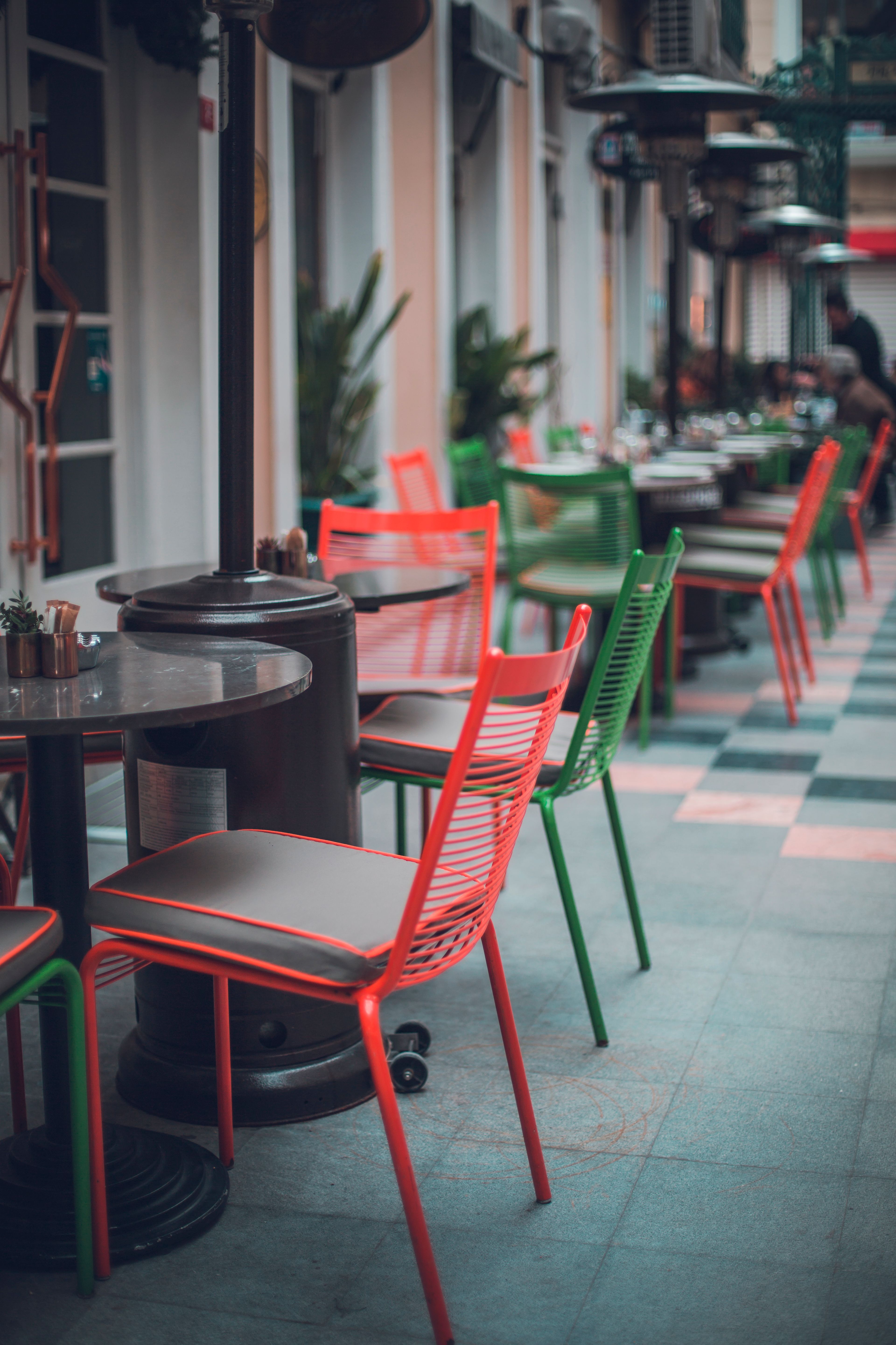 Stylish street cafe interior with colorful chairs · Free Stock Photo