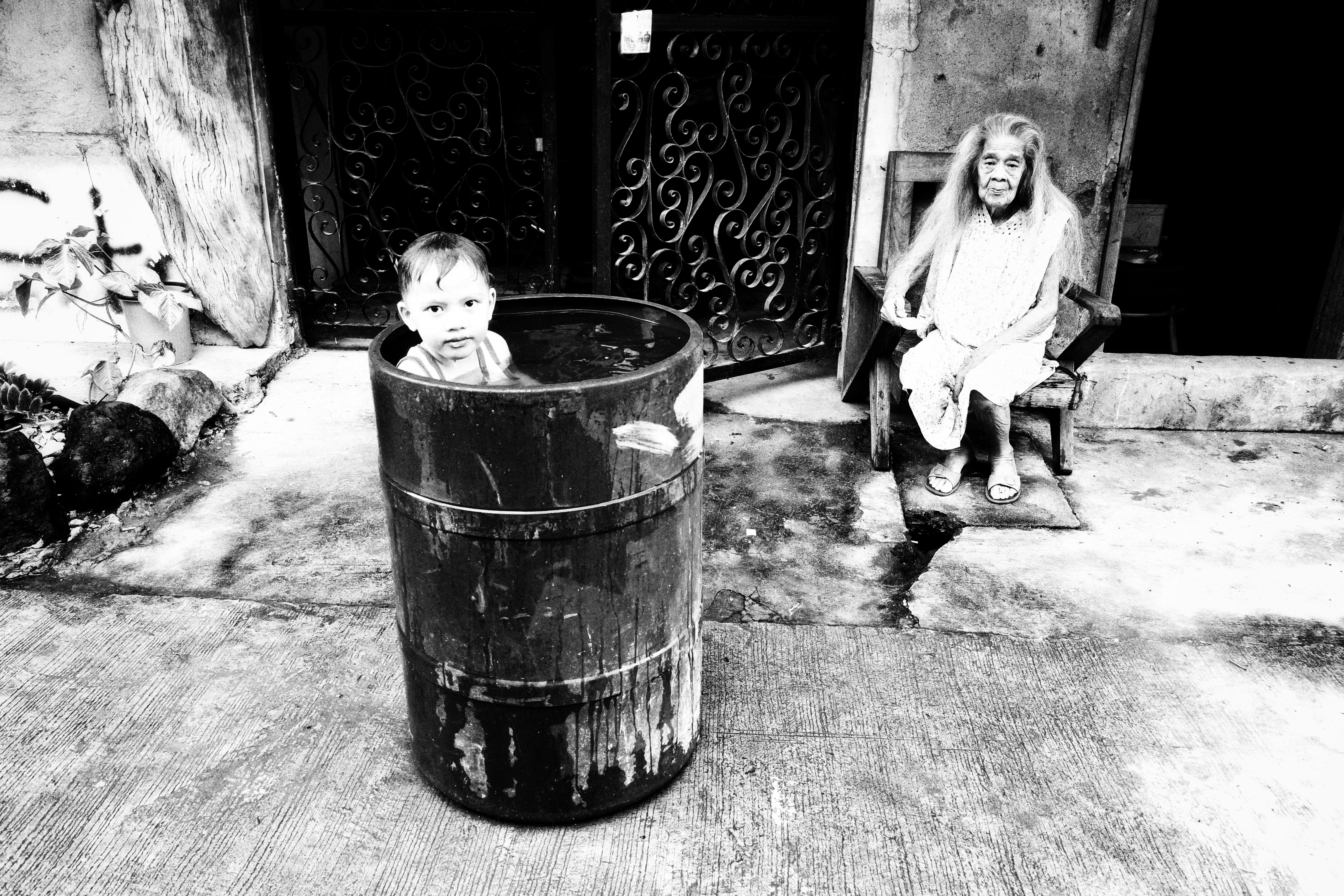 Black and White Portrait of Child in Barrel · Free Stock Photo