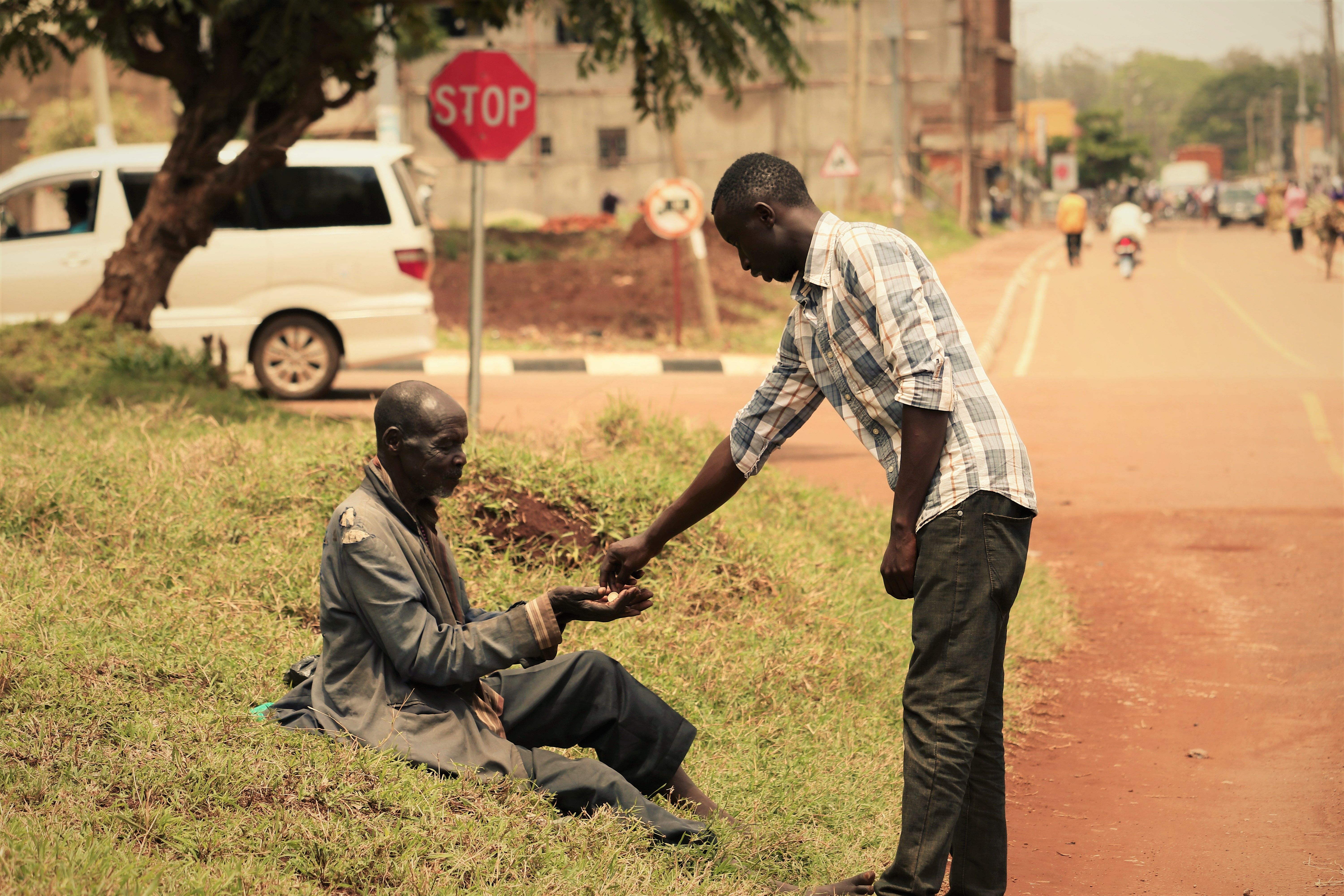 Heartwarming Act of Kindness on Tororo Street · Free Stock Photo