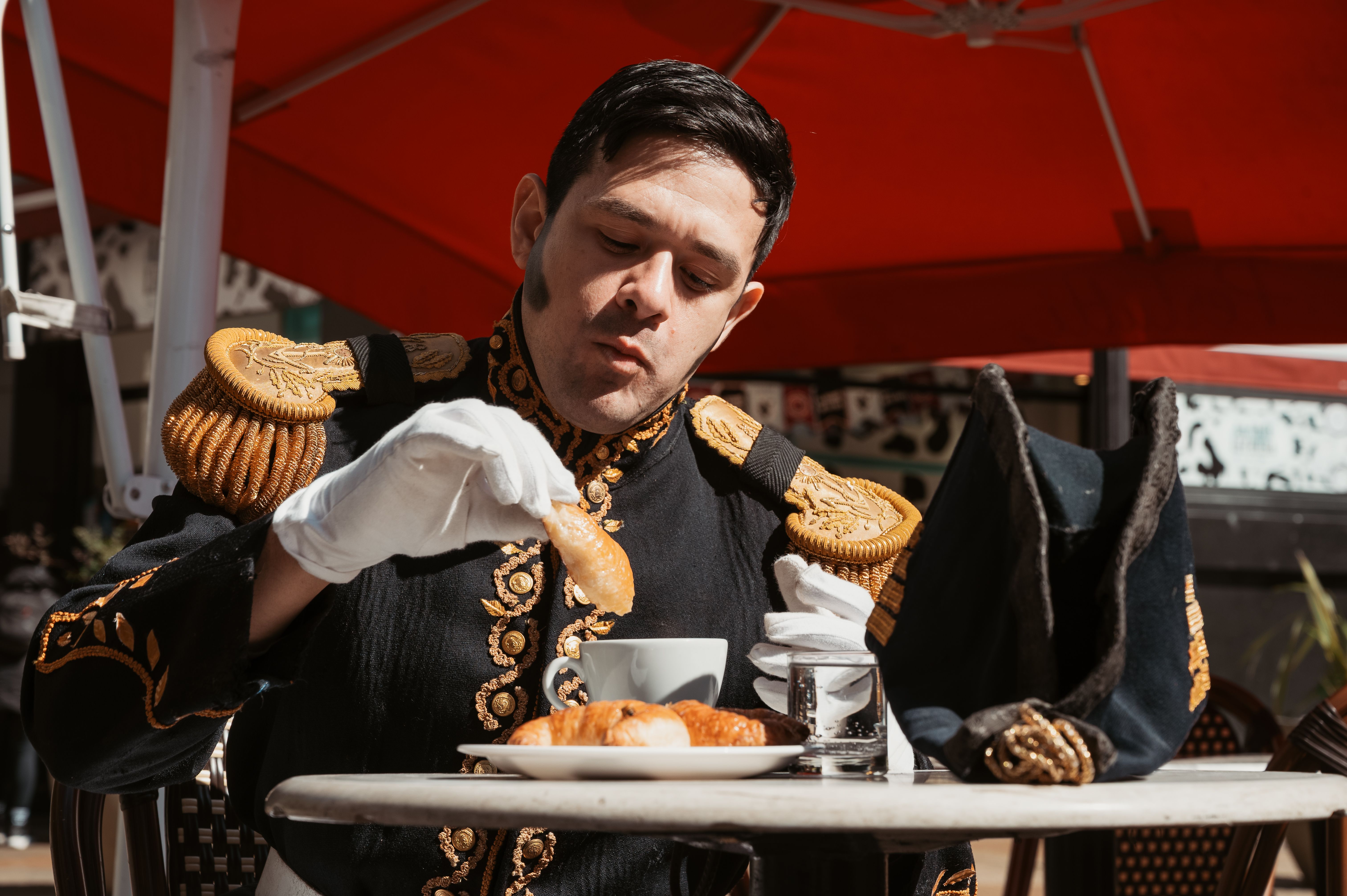 Man in Historical Costume Enjoying Coffee Outdoors · Free Stock Photo