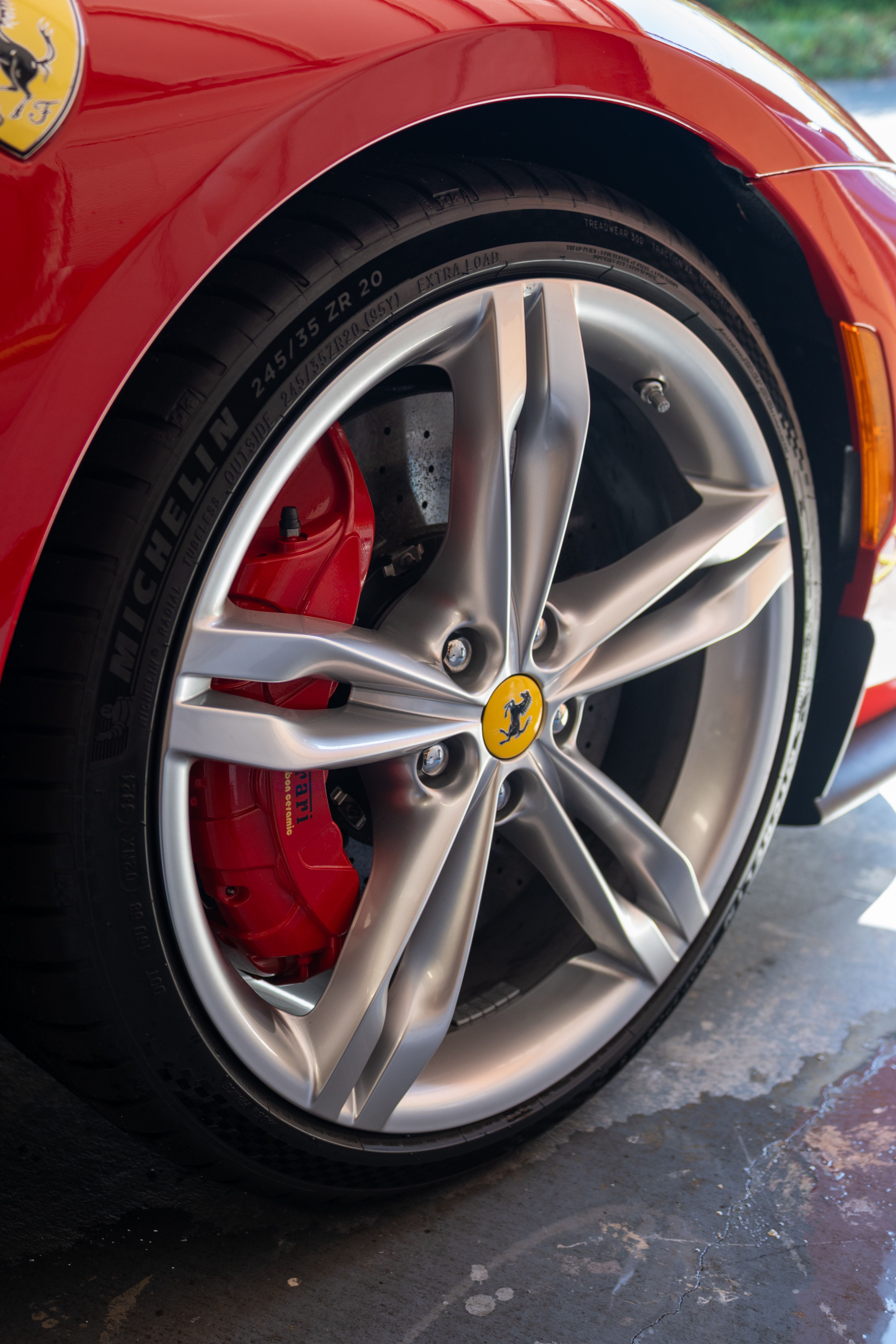 Close-up of Sports Car Wheel with Red Brake Caliper · Free Stock Photo
