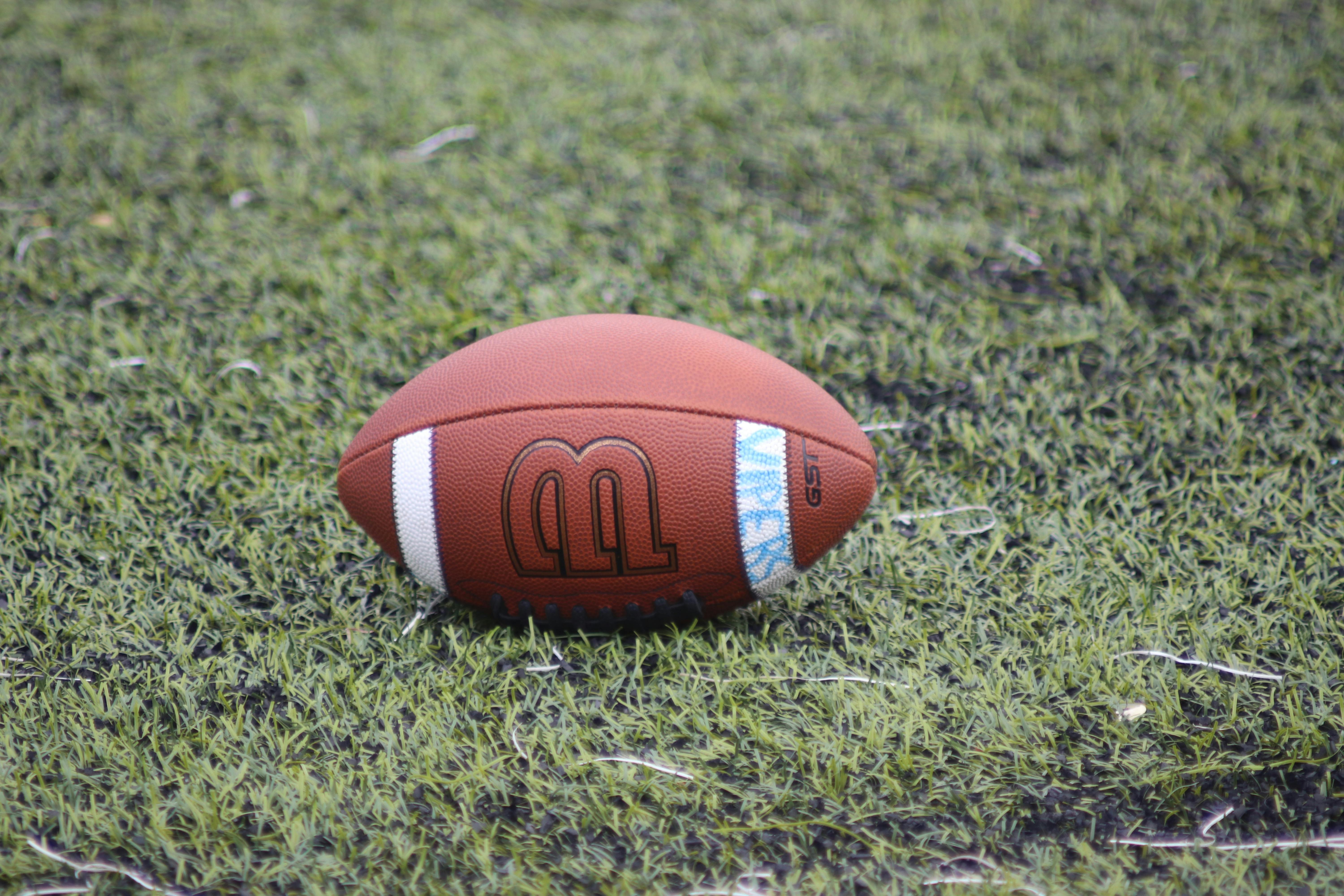 Selective Focus Close-up Photo of Brown Wilson Pigskin Football on ...