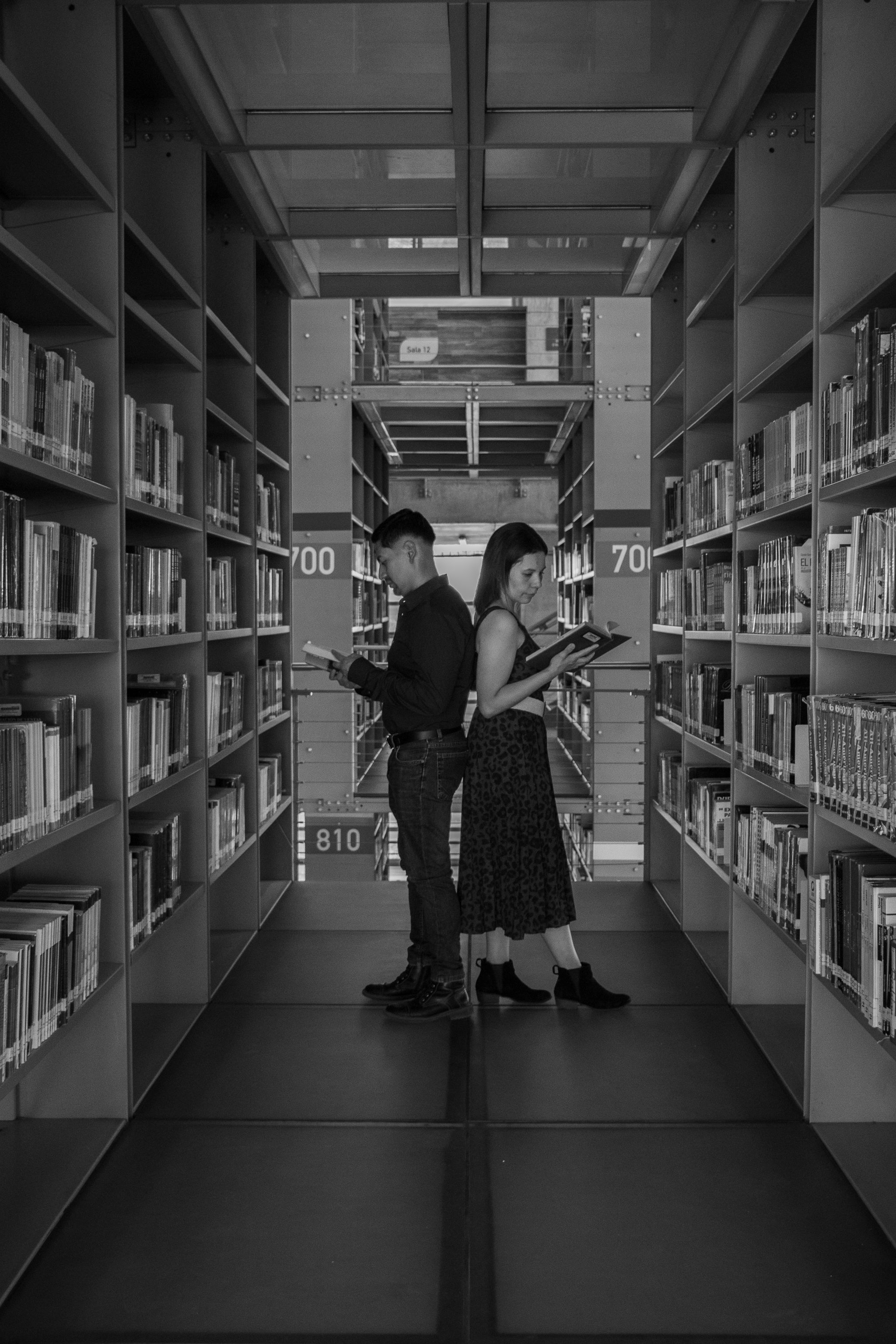 Young Adults Reading in a Modern Library · Free Stock Photo