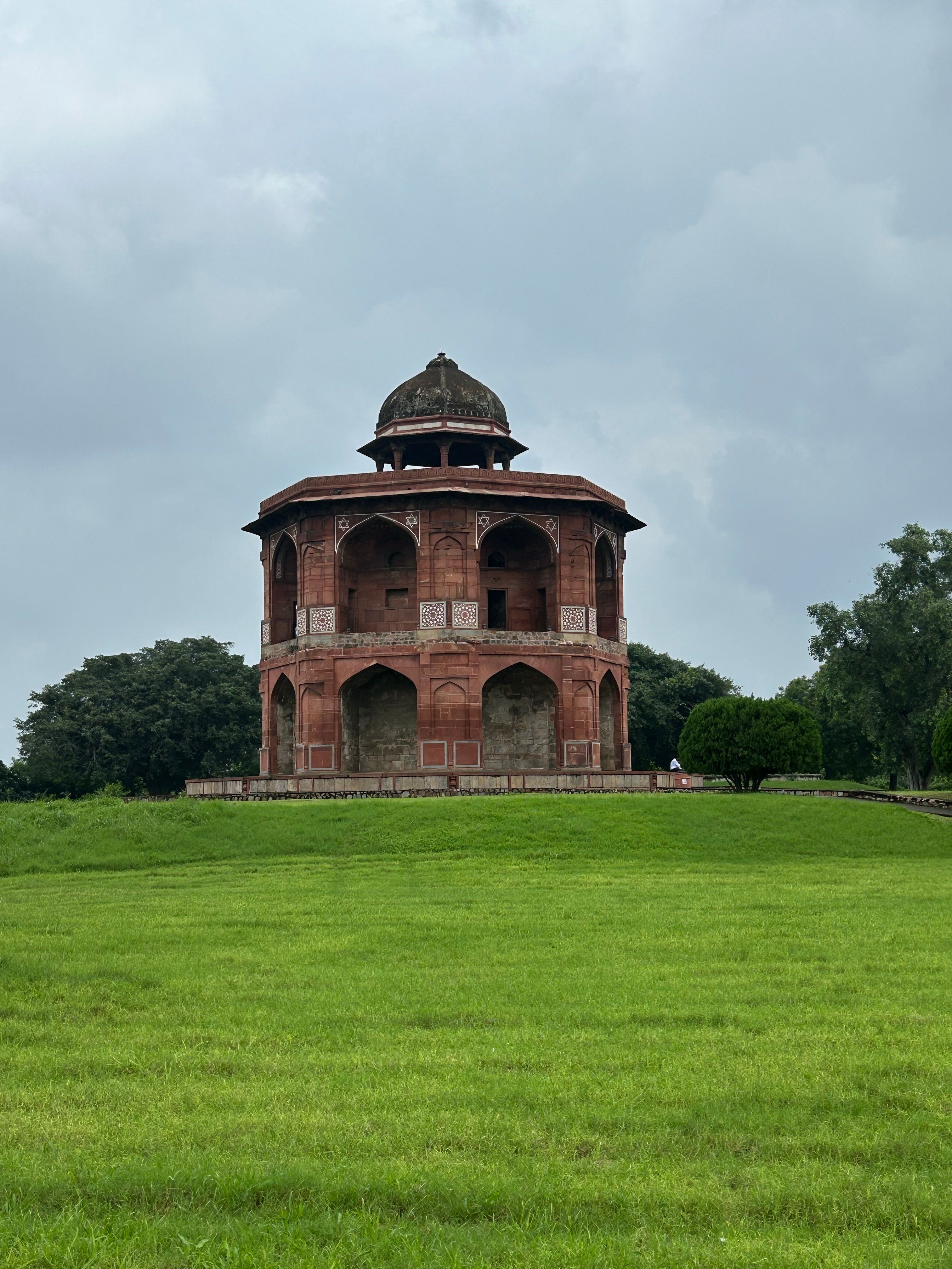 Historic Red Stone Pavilion in Lush Greenery · Free Stock Photo
