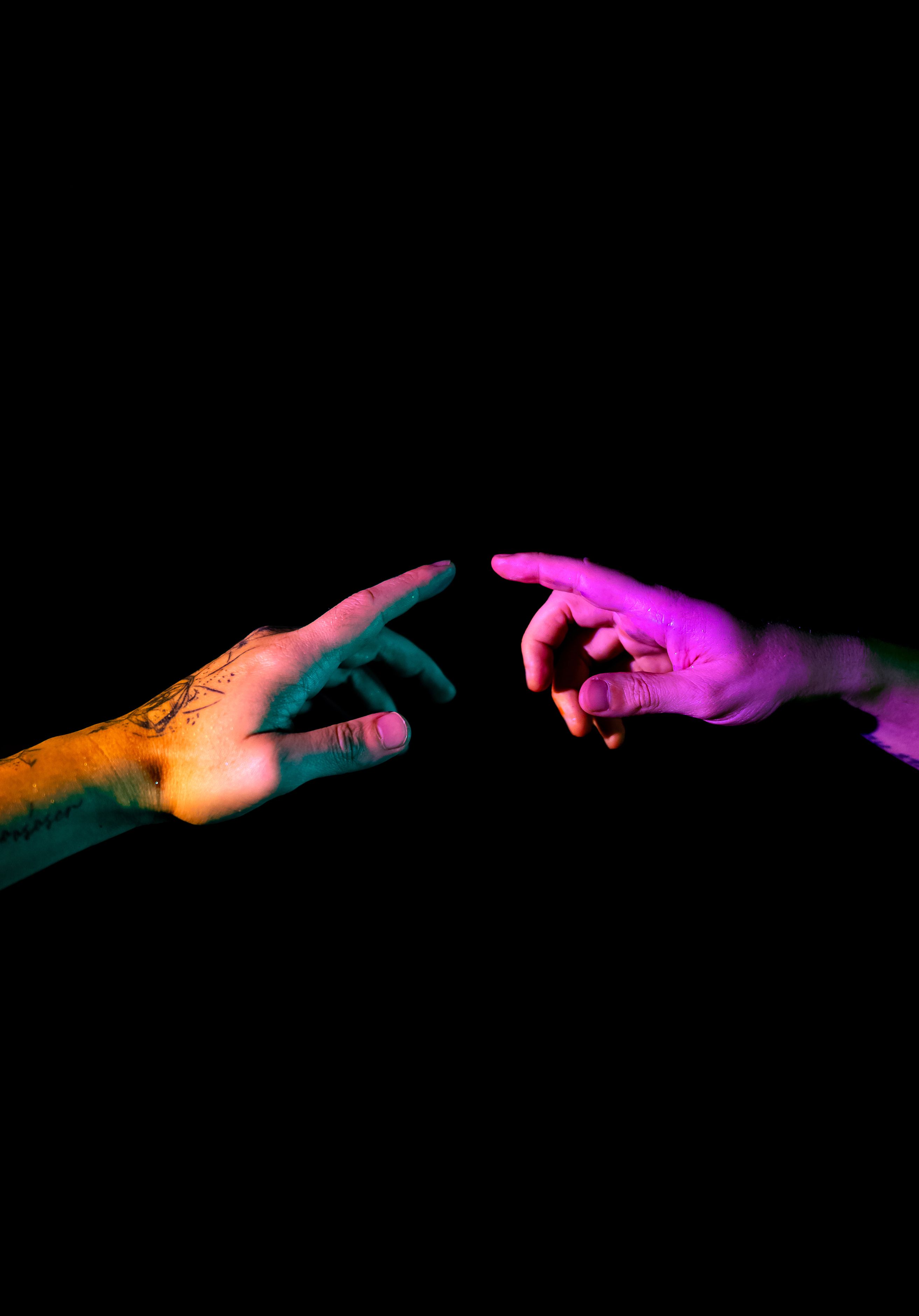 Dramatic Colorful Hands Reaching in Darkness · Free Stock Photo