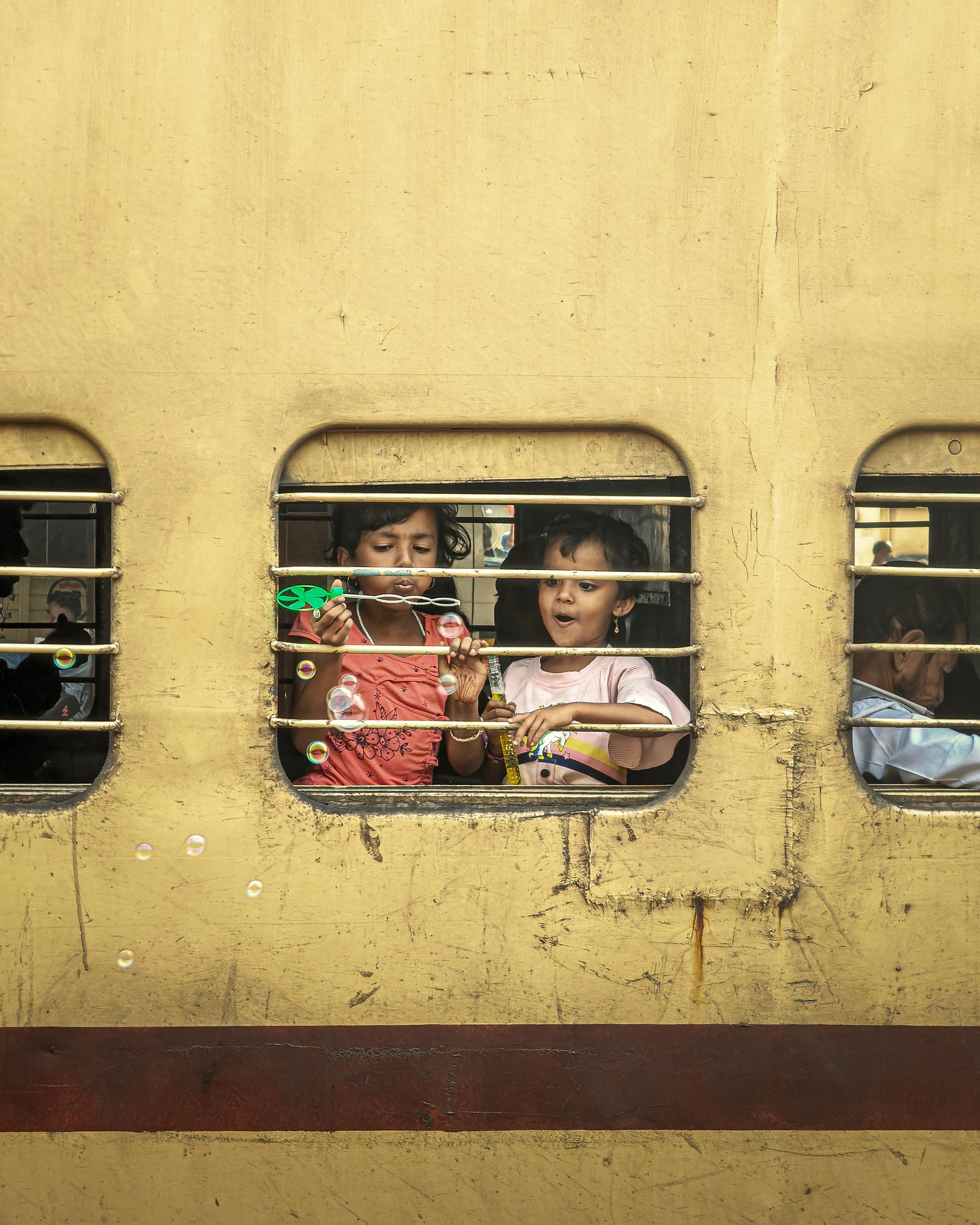 Children Blowing Bubbles on Train Journey · Free Stock Photo