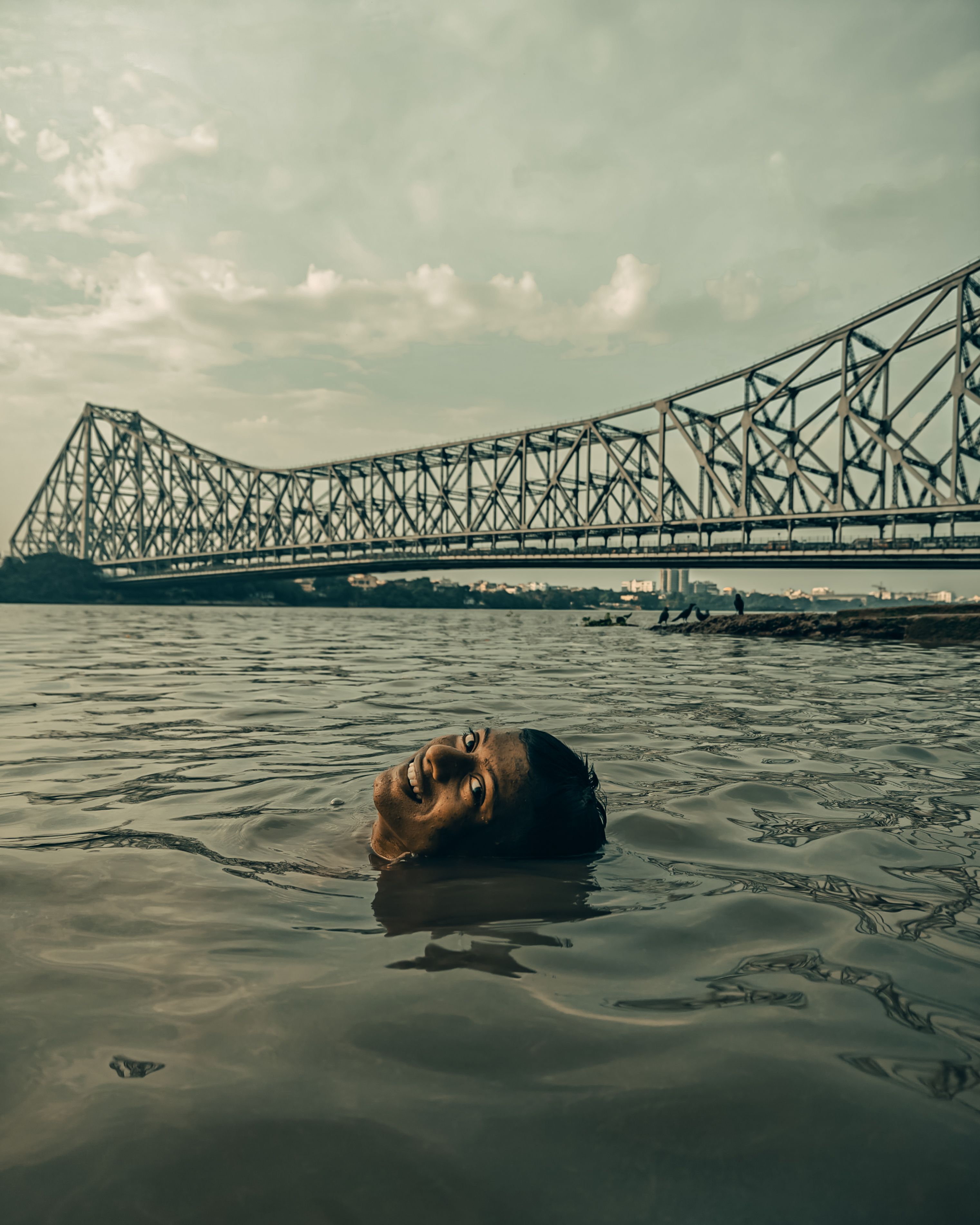 Man Swimming Near Howrah Bridge in Kolkata · Free Stock Photo