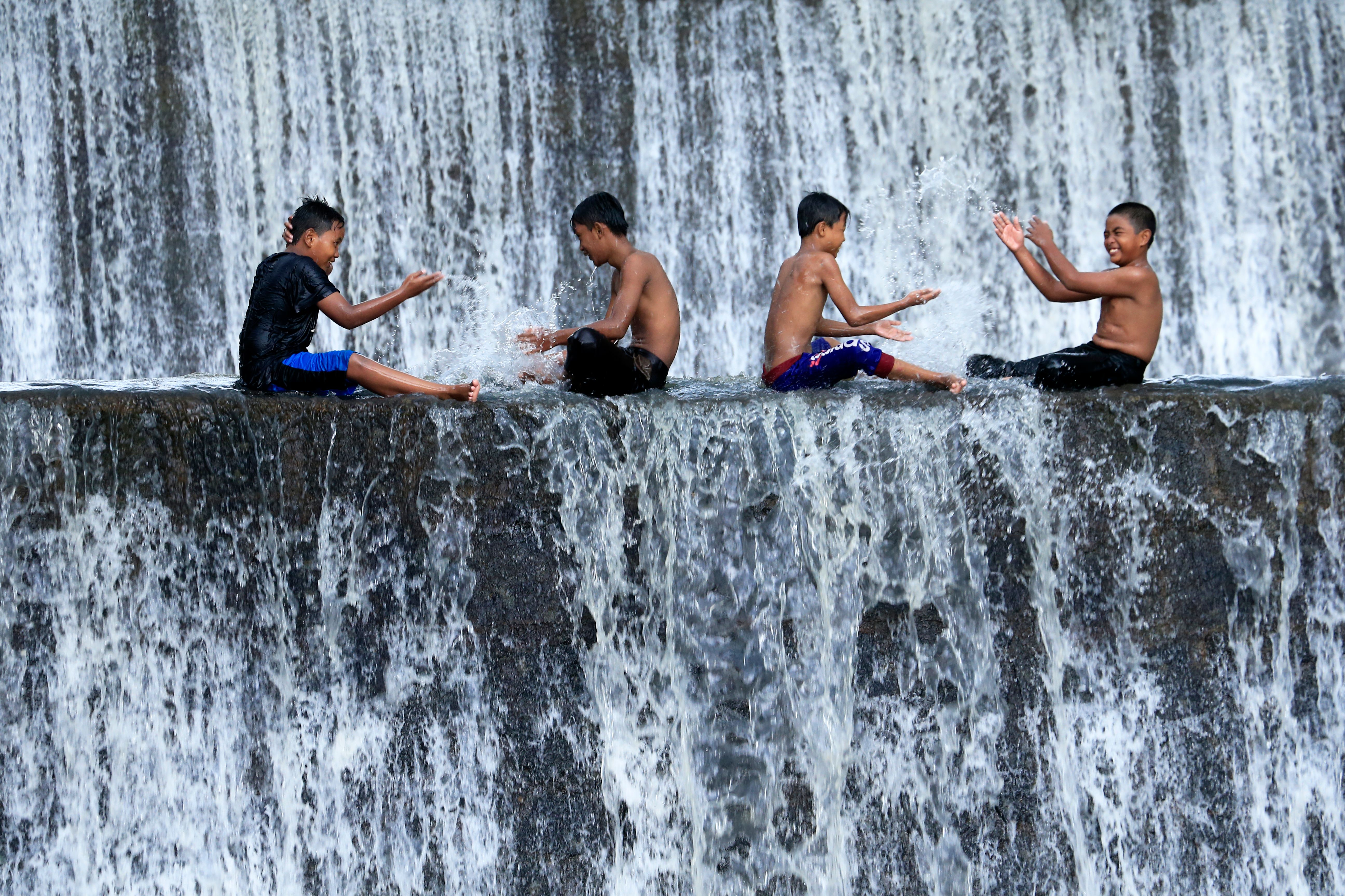 Boys Playing on Cascading Waterfall Edge · Free Stock Photo