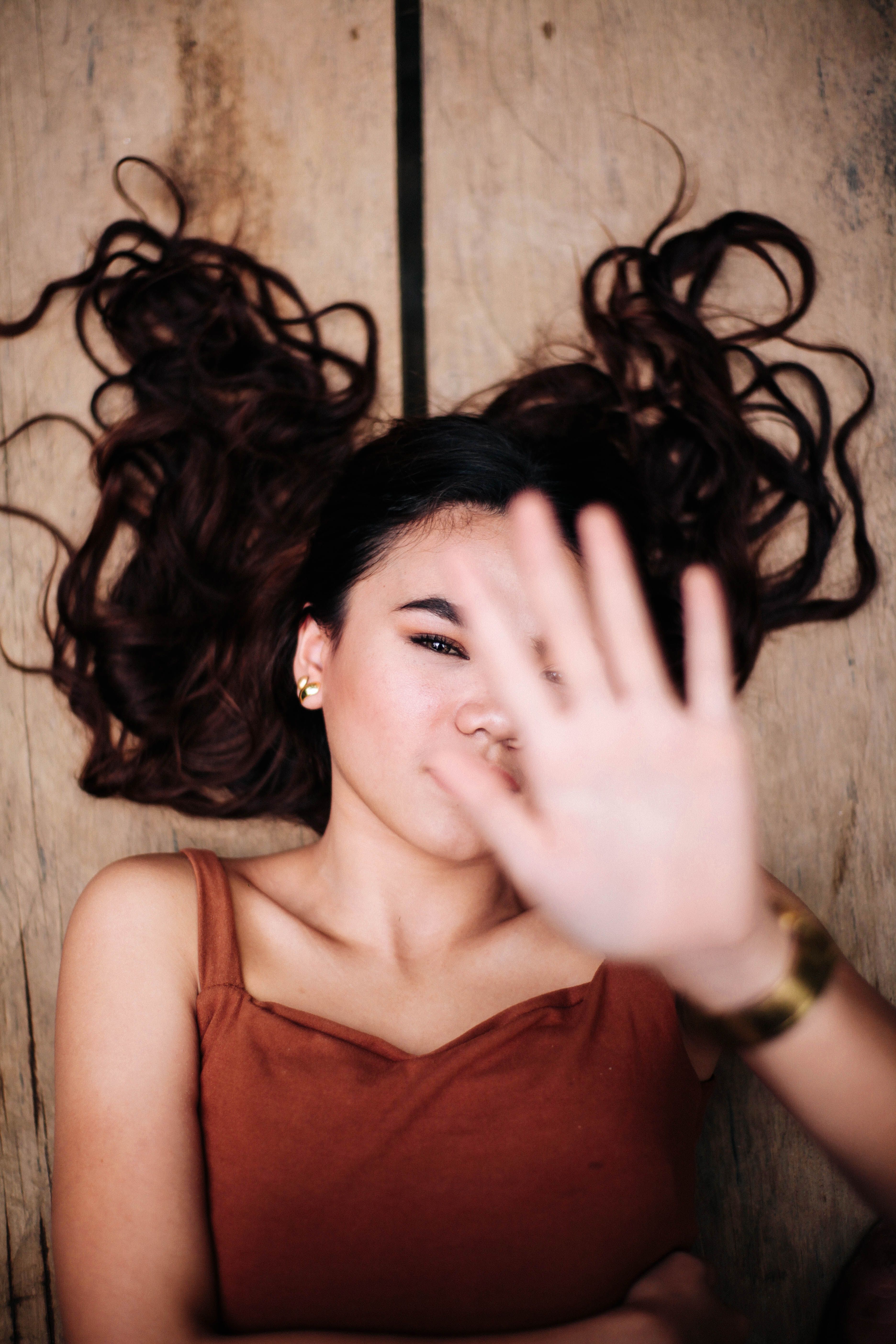 Photo Of Woman Laying On Wooden Surface · Free Stock Photo