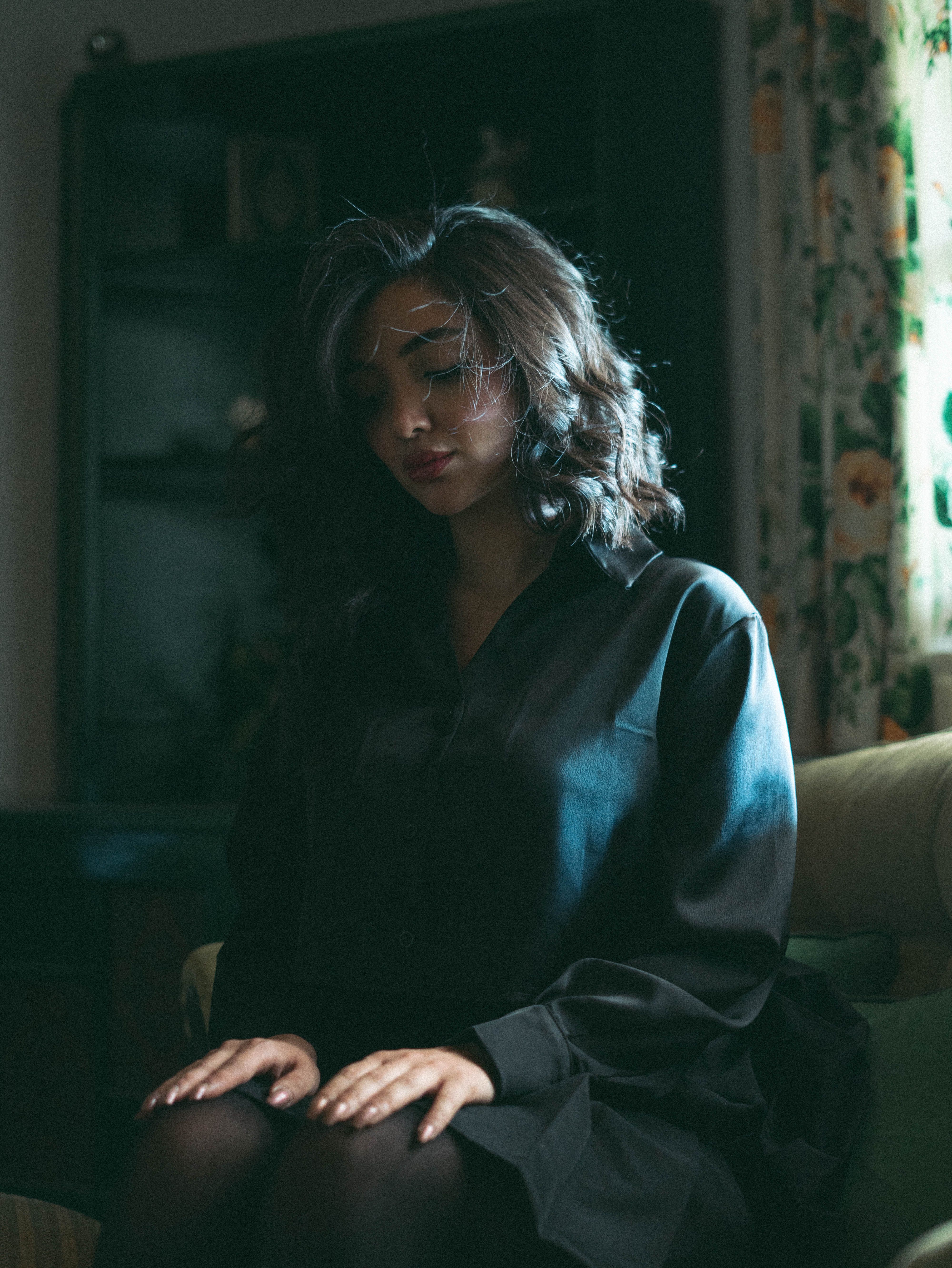 Moody Portrait of a Woman in Dim Light · Free Stock Photo