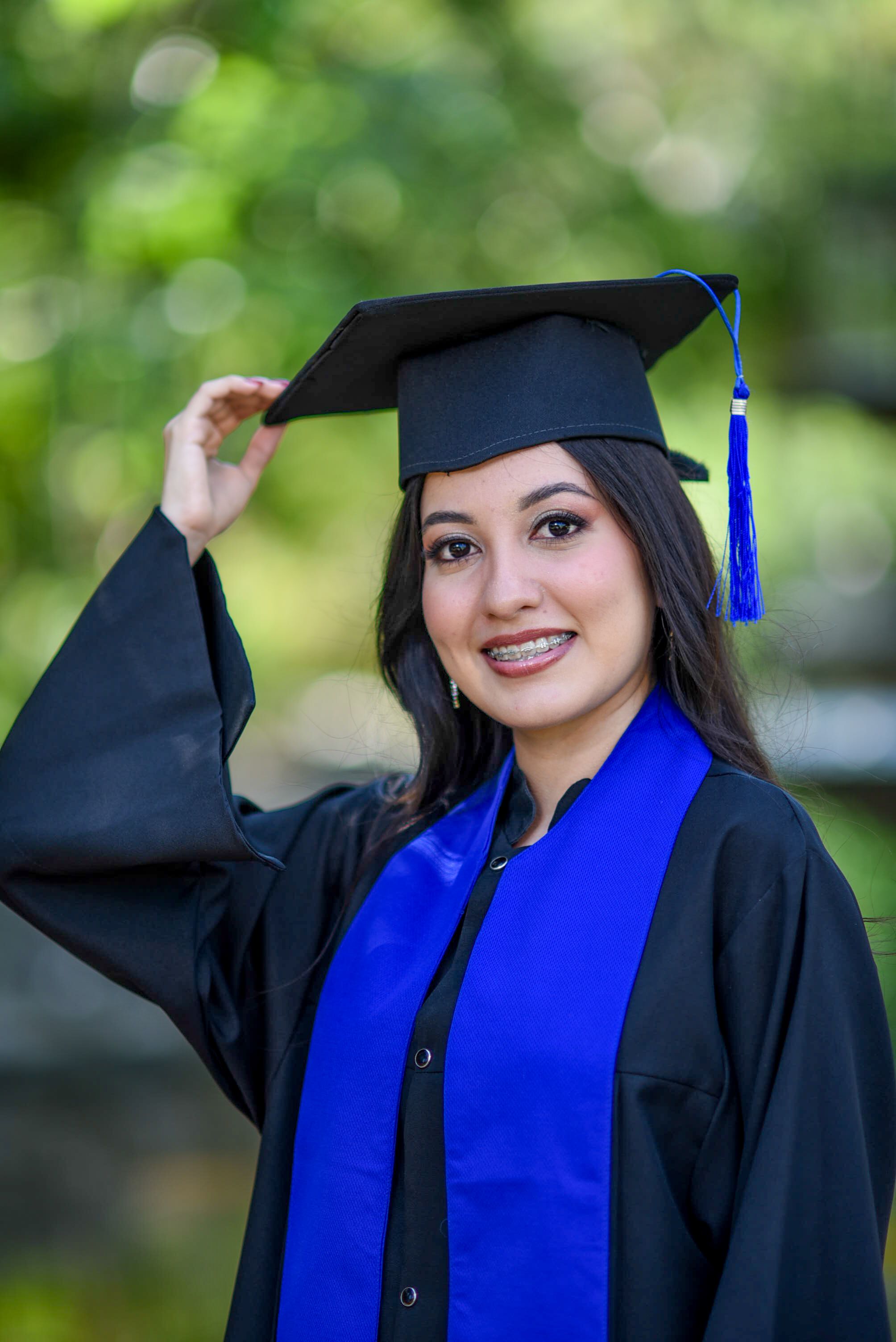 Portrait of Smiling Graduate in Cap and Gown · Free Stock Photo
