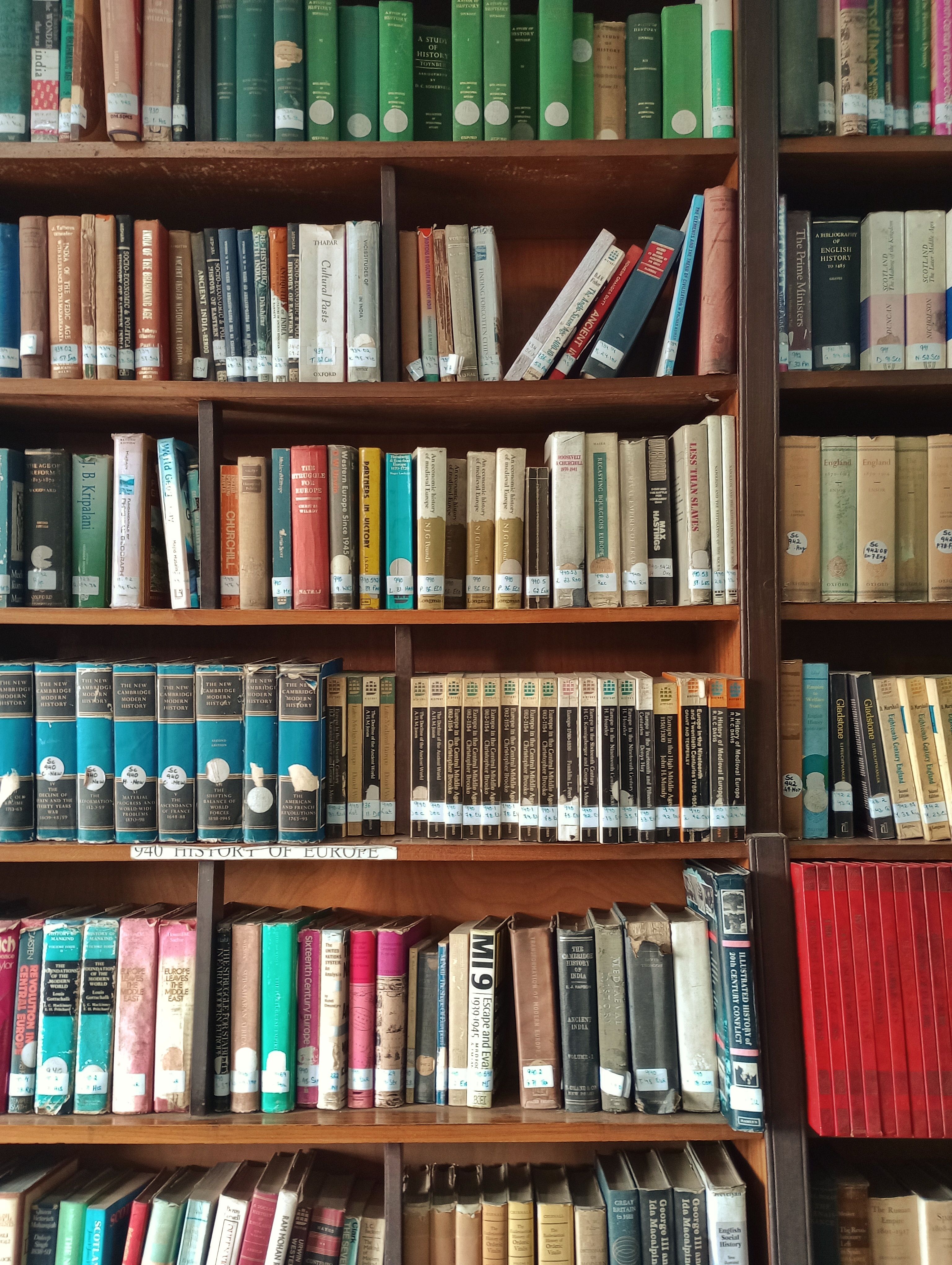 Endless Library Aisle with Colorful Books · Free Stock Photo