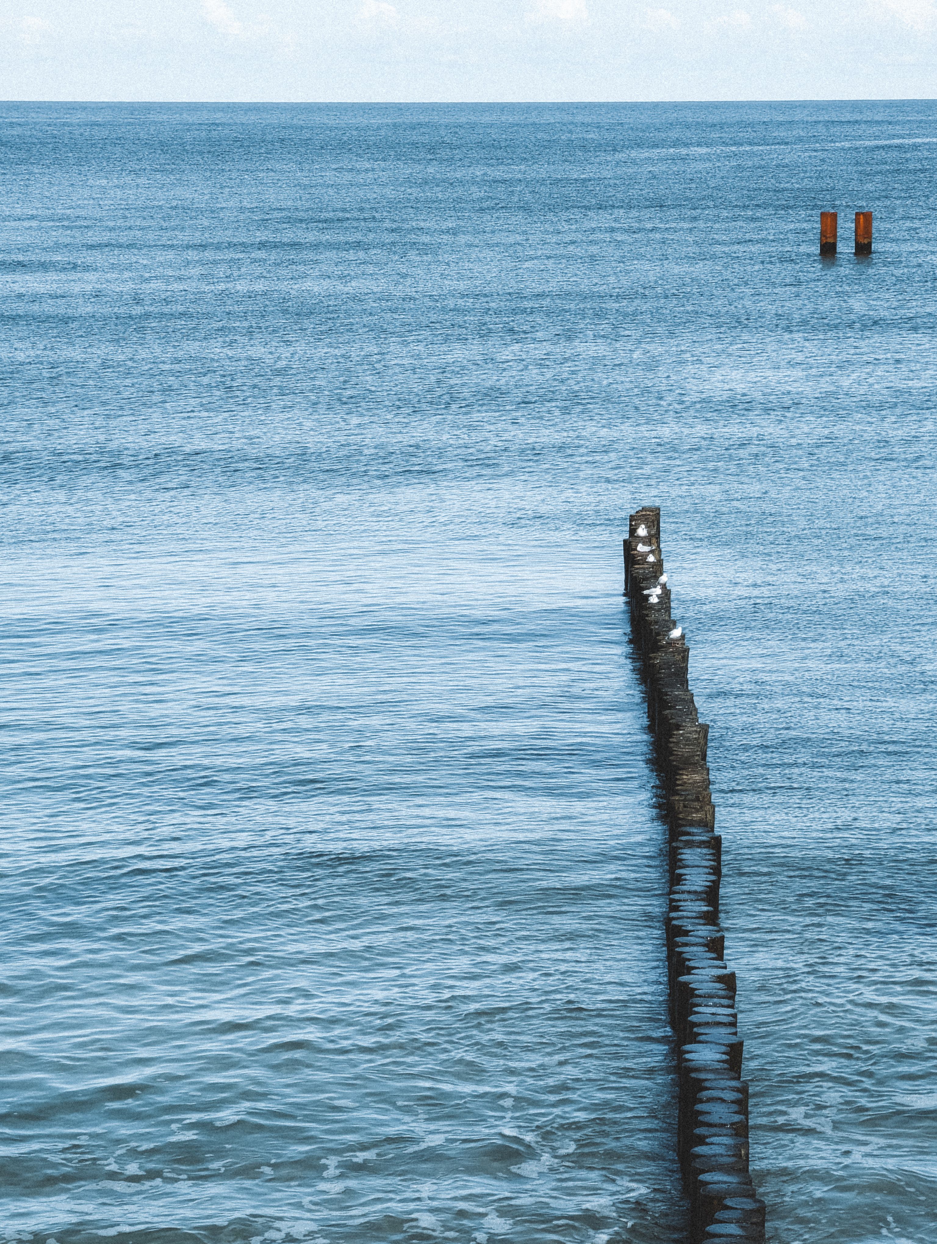 Serene View of Seaside Pier and Calm Ocean Waves · Free Stock Photo