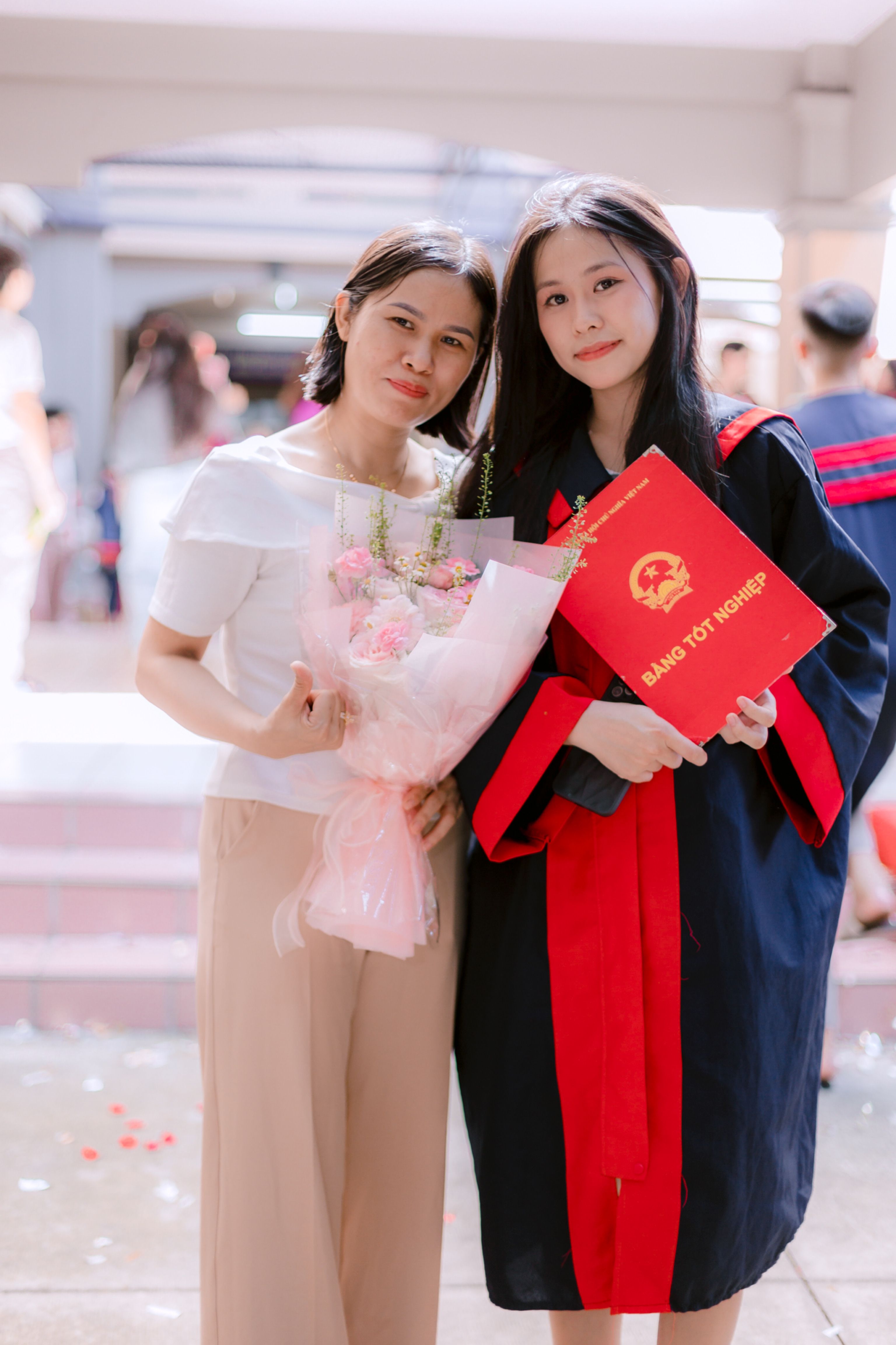 Graduation Day Celebration with Diploma and Flowers · Free Stock Photo