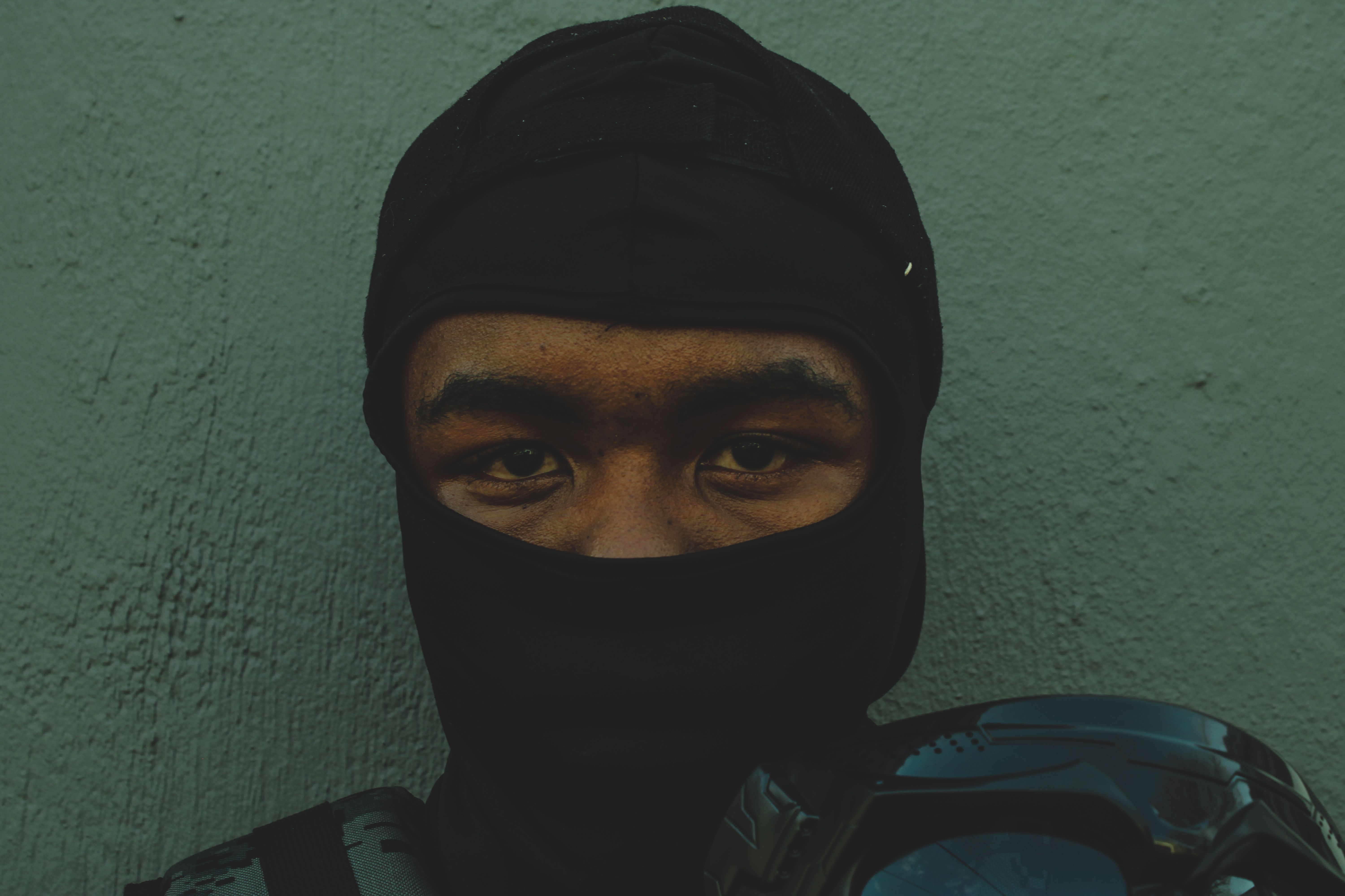 Portrait of a Black-Clad Individual against a Wall · Free Stock Photo