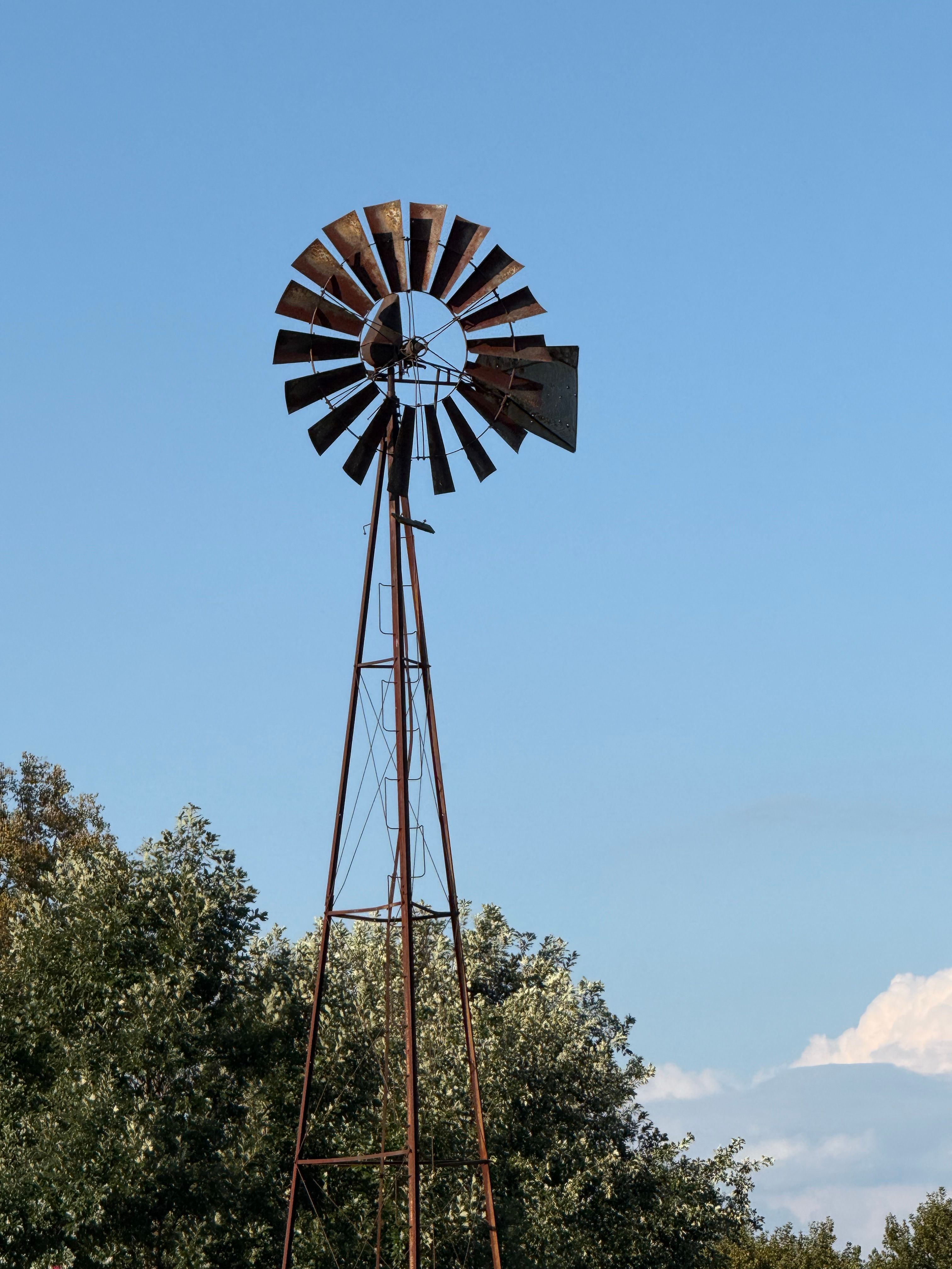 Rustic Windmill Against Vibrant Blue Sky · Free Stock Photo