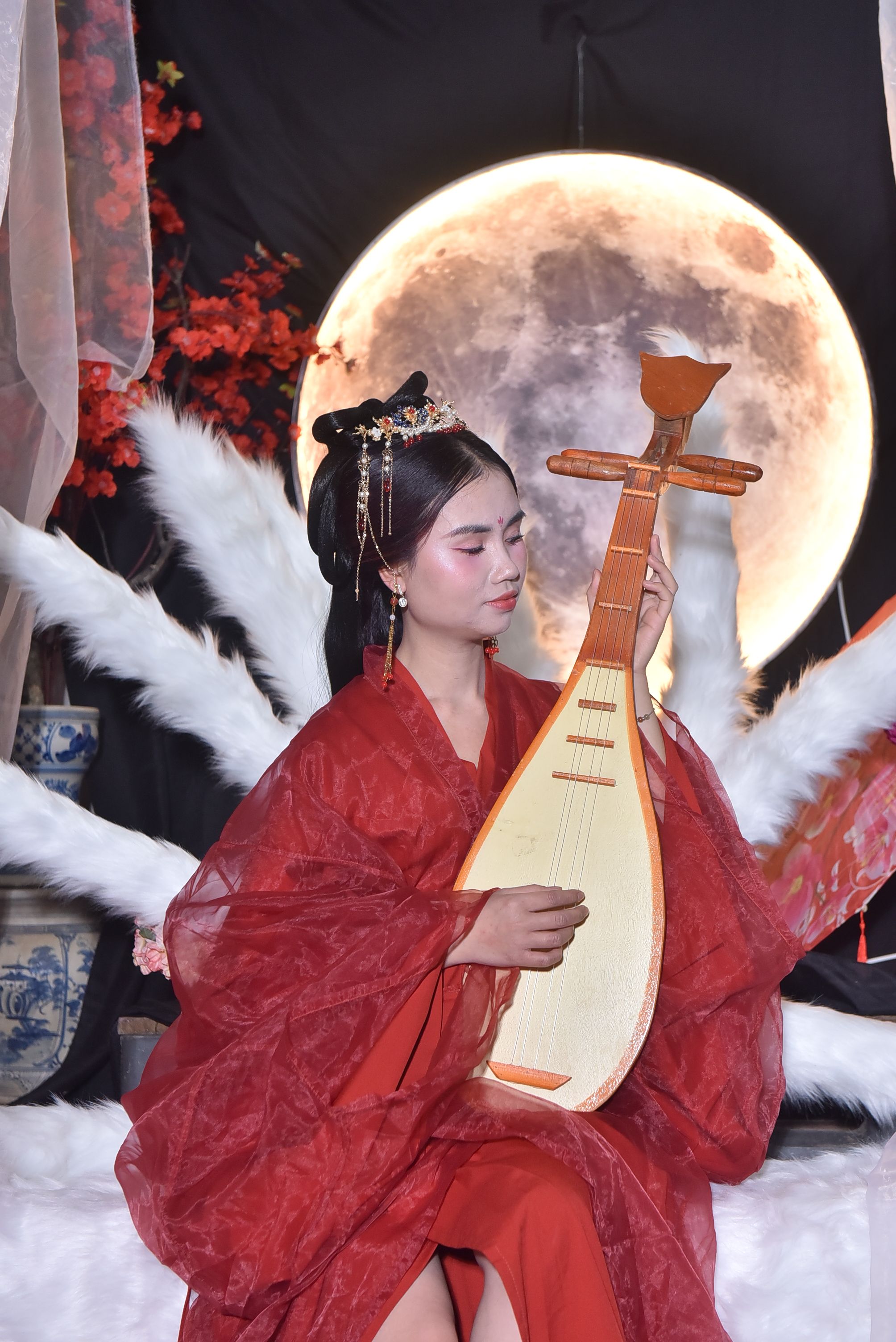 Elegant Woman Playing Pipa in Traditional Attire · Free Stock Photo