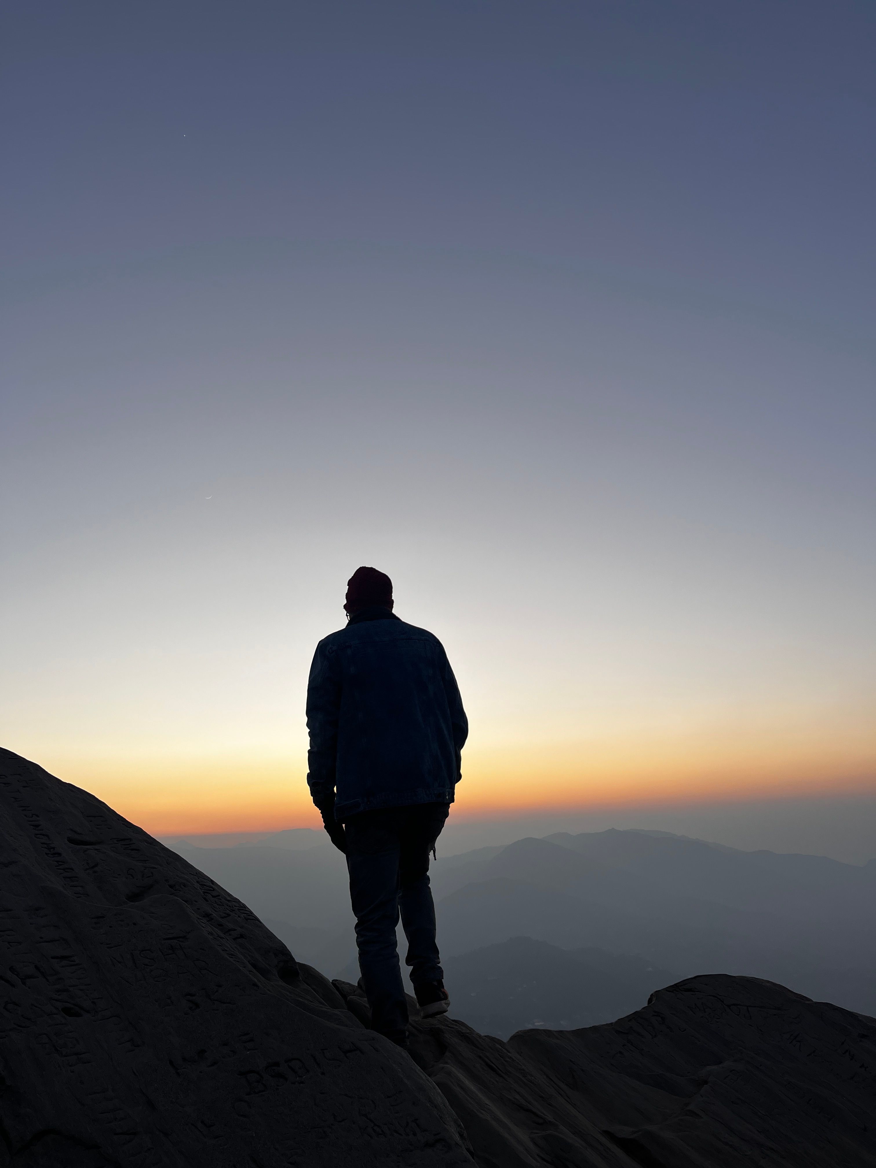 Male traveler standing on top of mountain and admiring landscape · Free ...