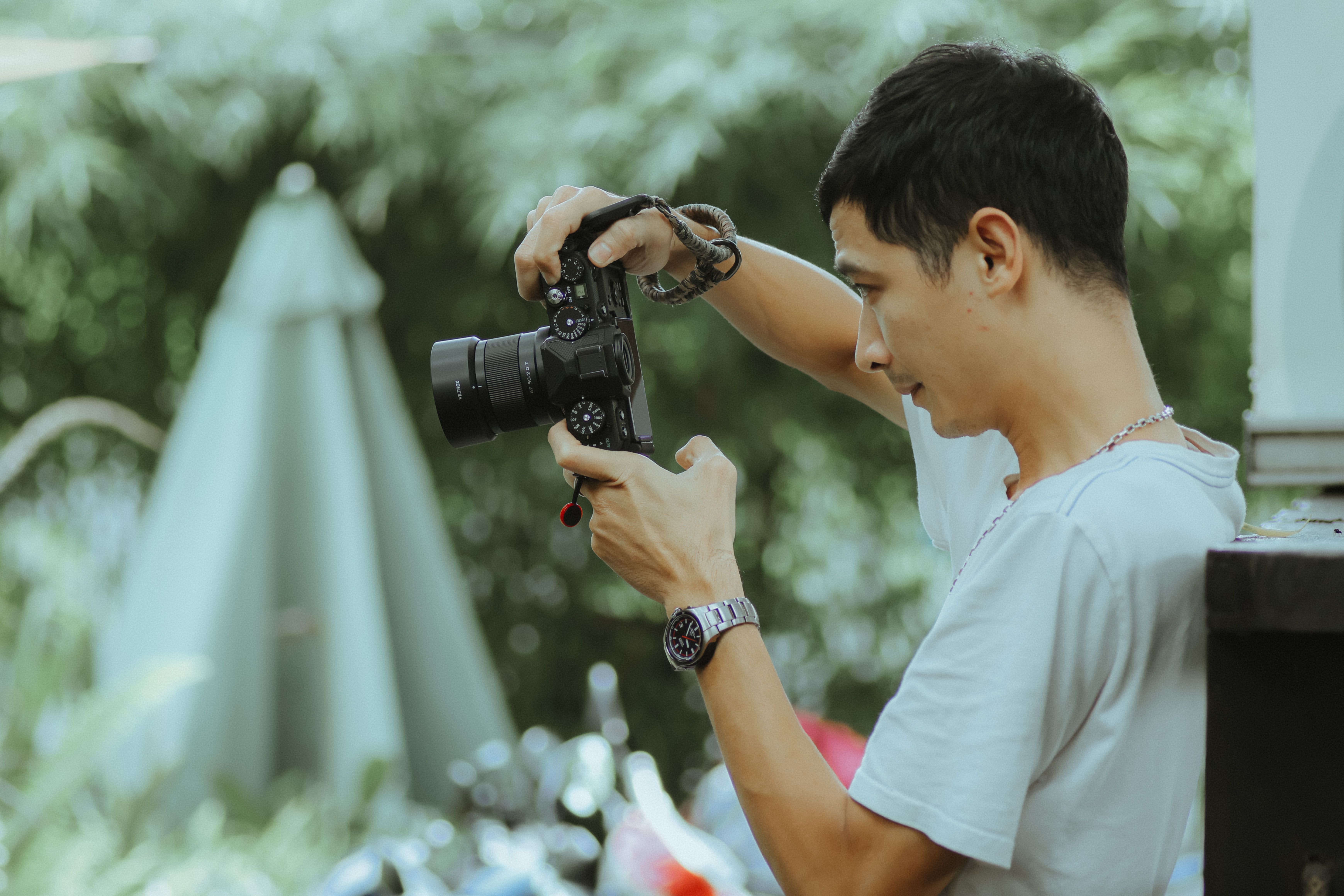 Photographer Capturing Outdoor Scene with Camera · Free Stock Photo