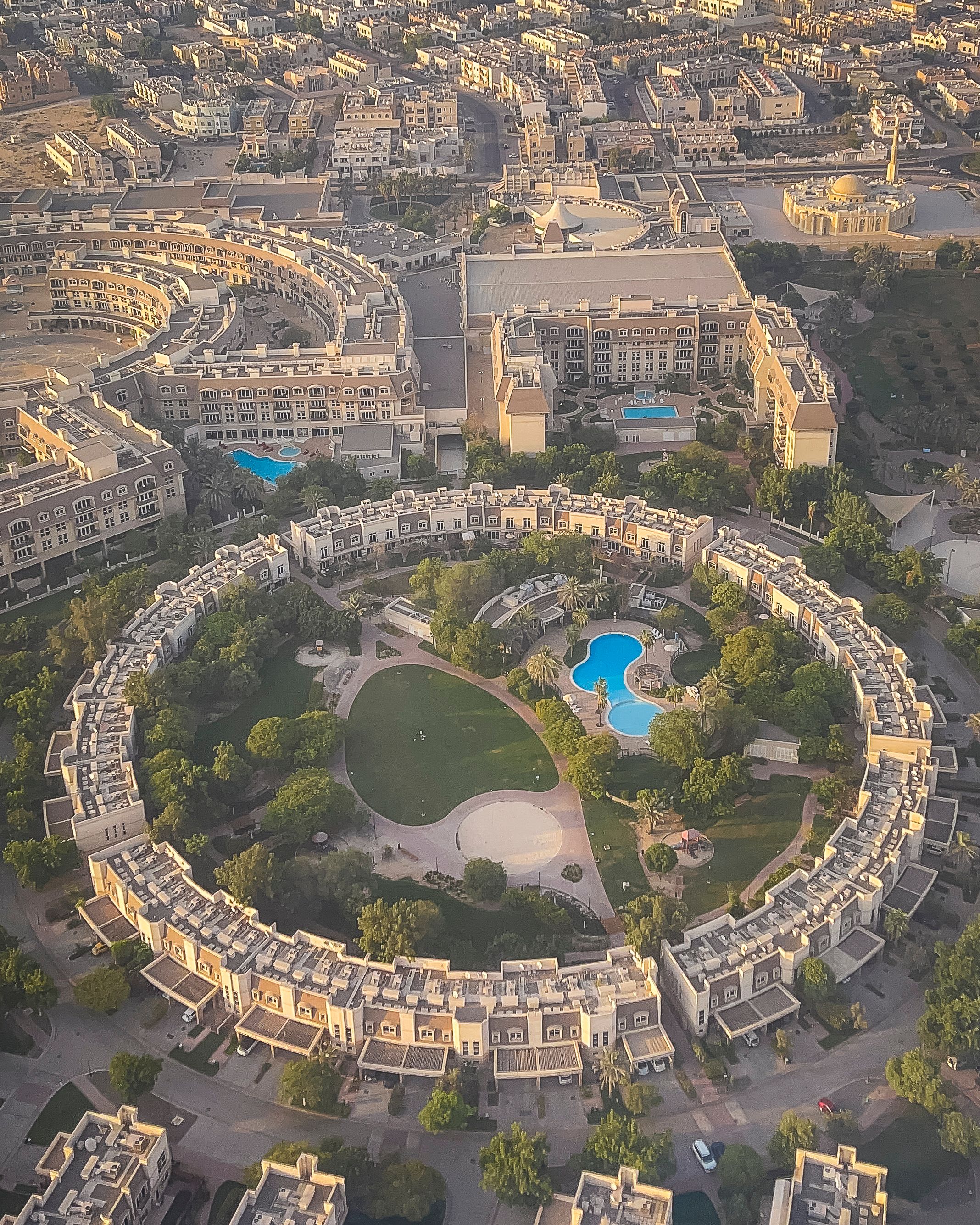 Aerial view of a circular residential complex in Dubai · Free Stock Photo