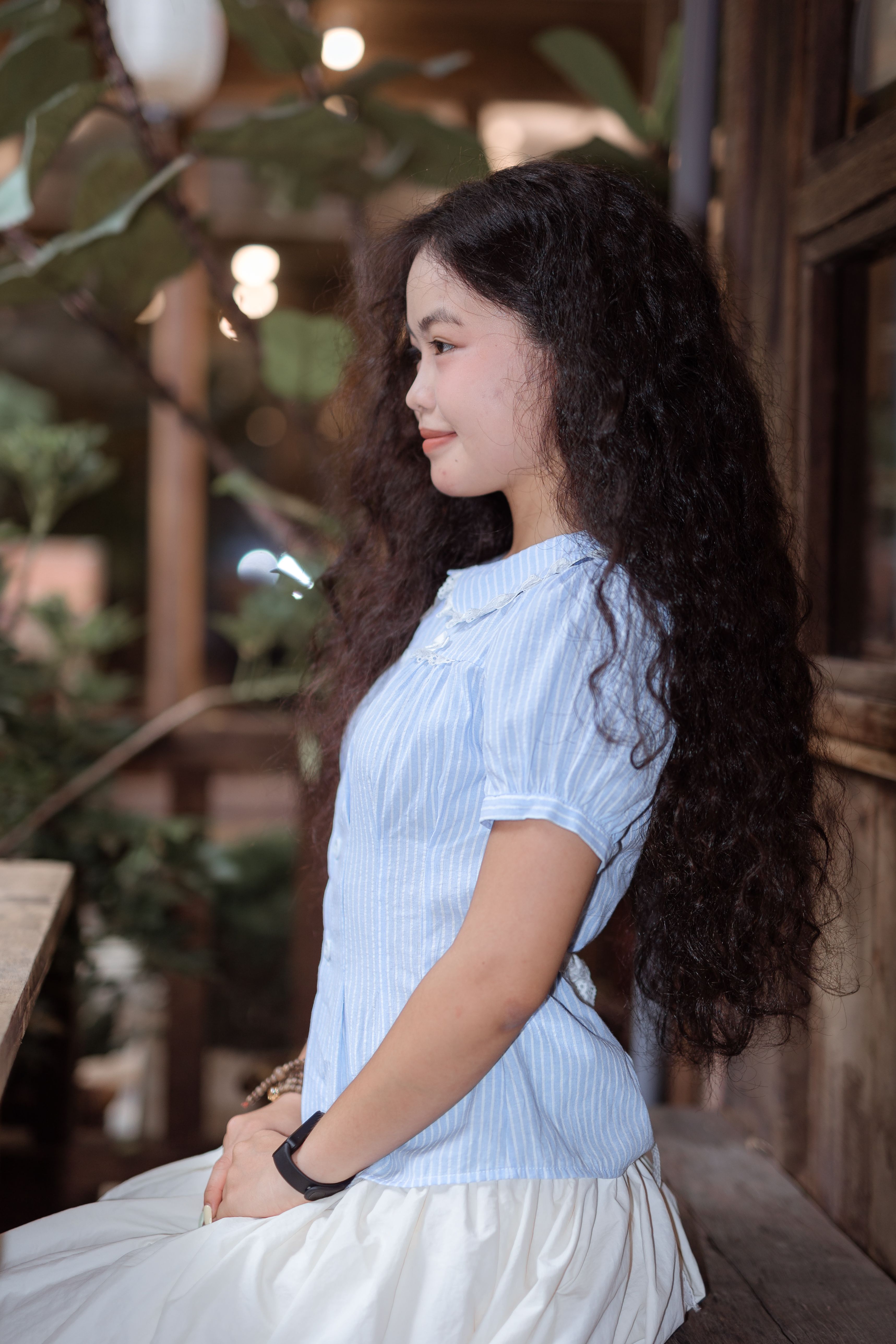 Profile Portrait of a Woman with Long Curly Hair · Free Stock Photo