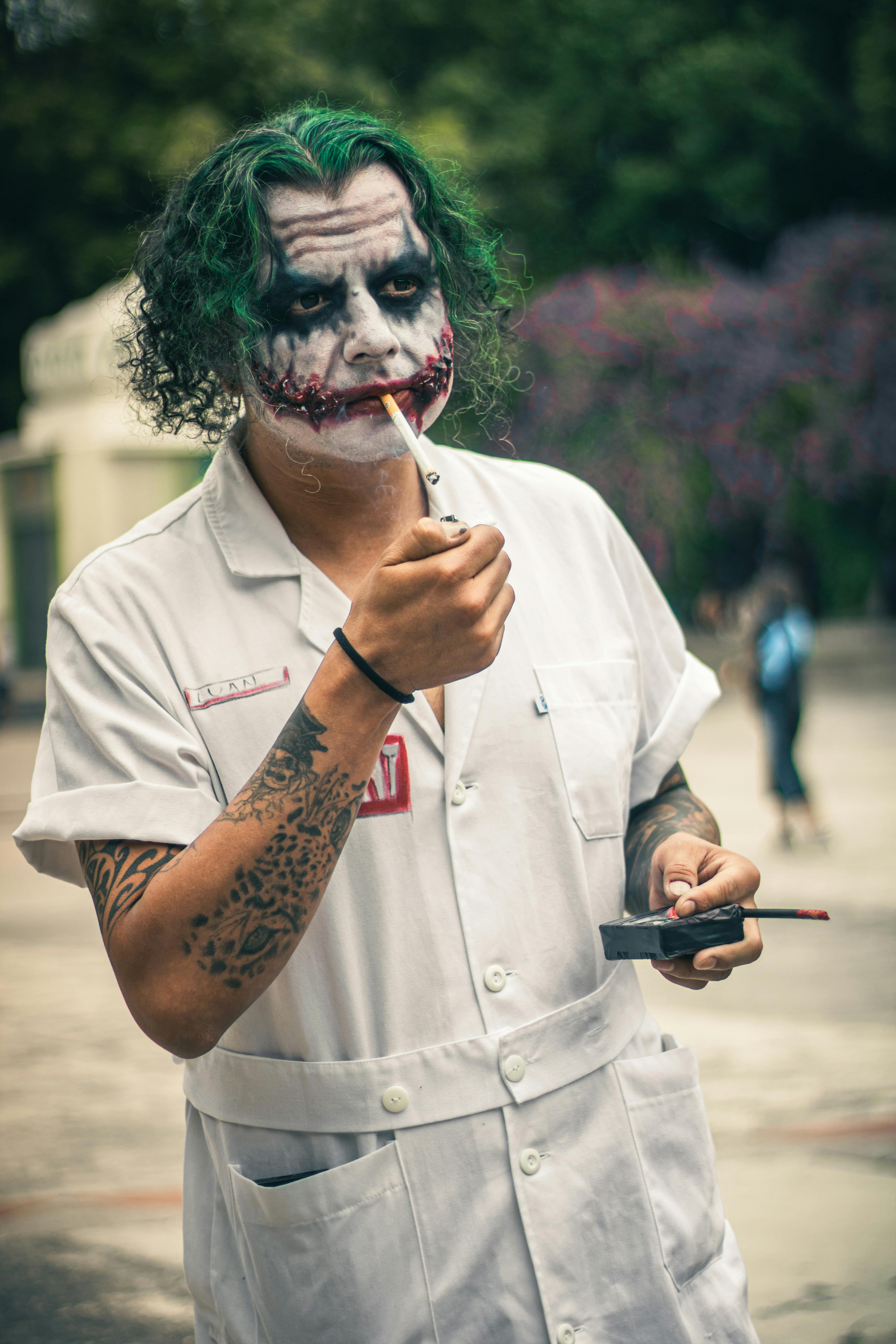 Cosplayer as Joker with Cigarette in Park · Free Stock Photo