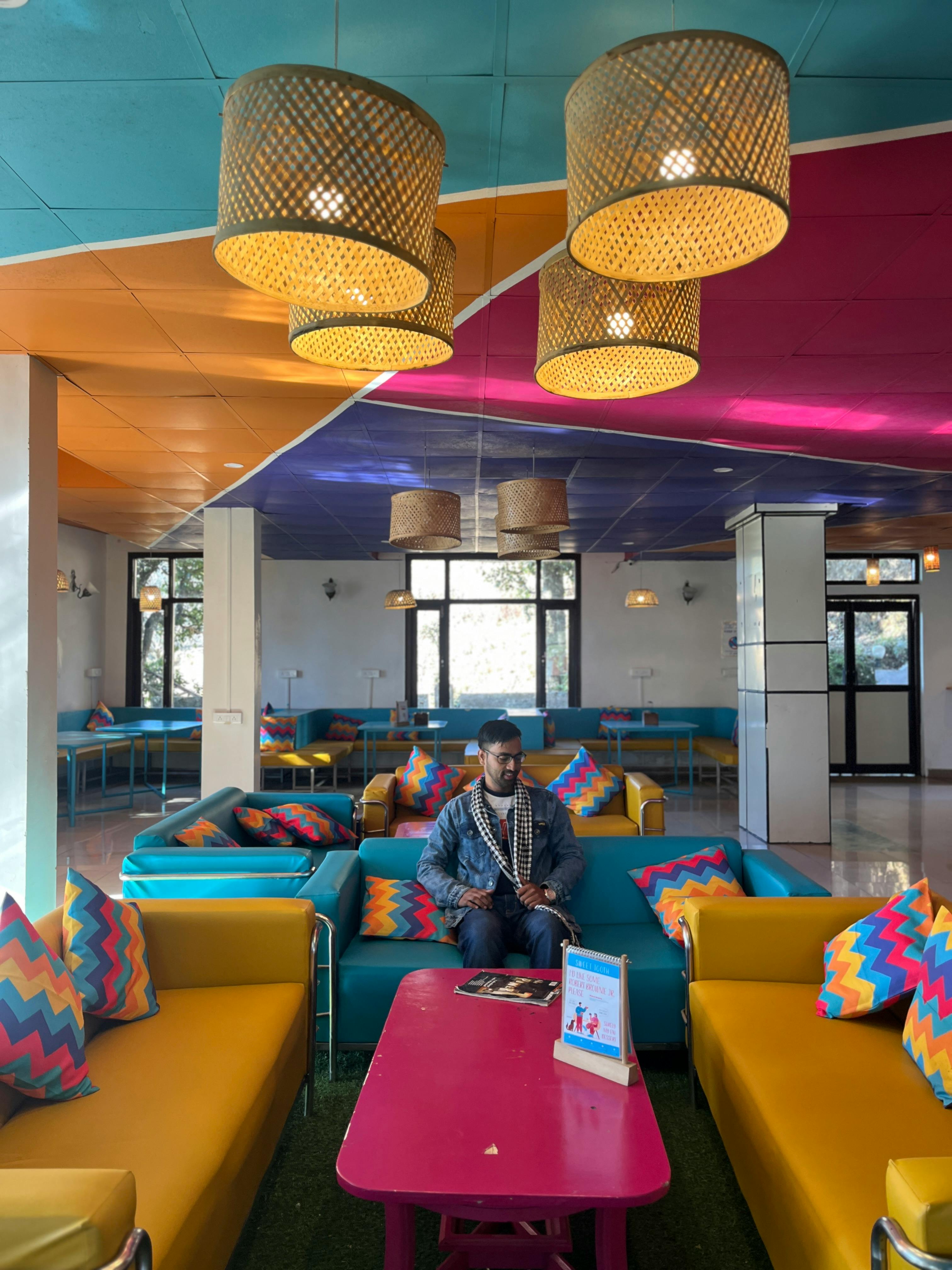 Vibrant Cafe Interior with Colorful Seating · Free Stock Photo