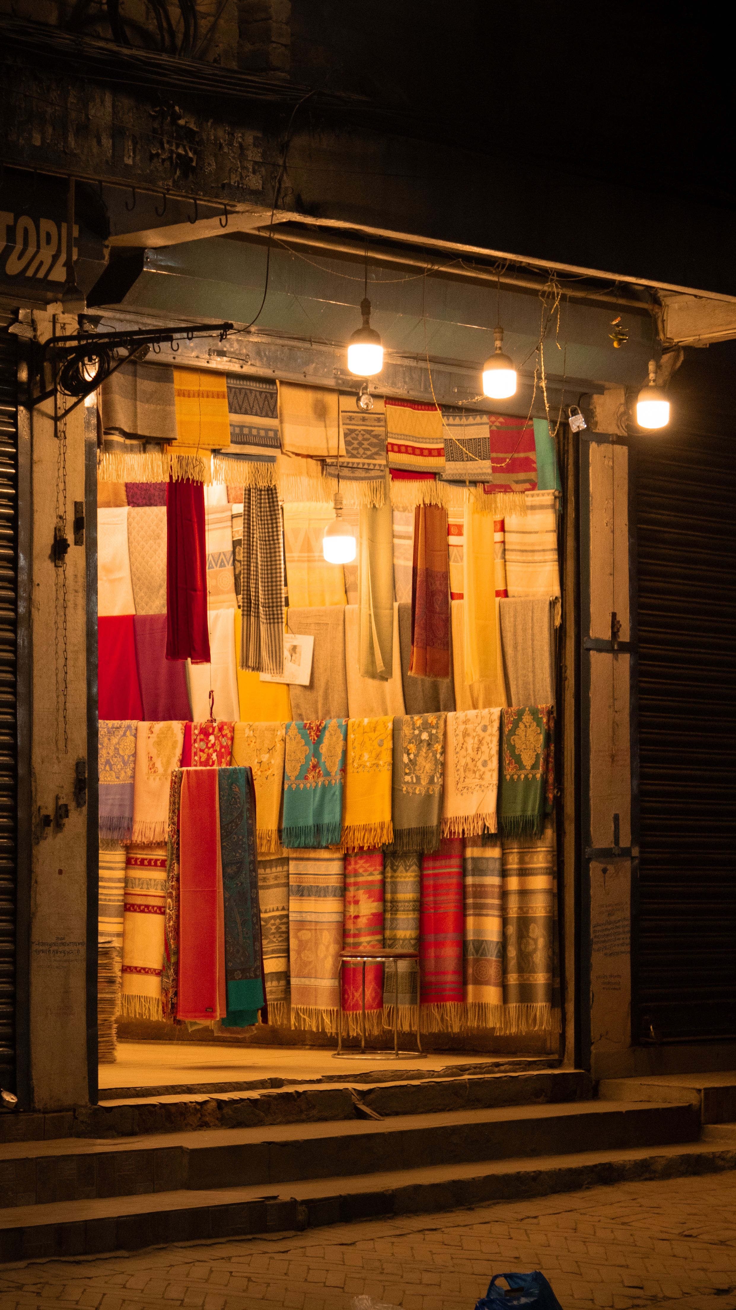 Vibrant Textiles Display in Kathmandu at Night · Free Stock Photo