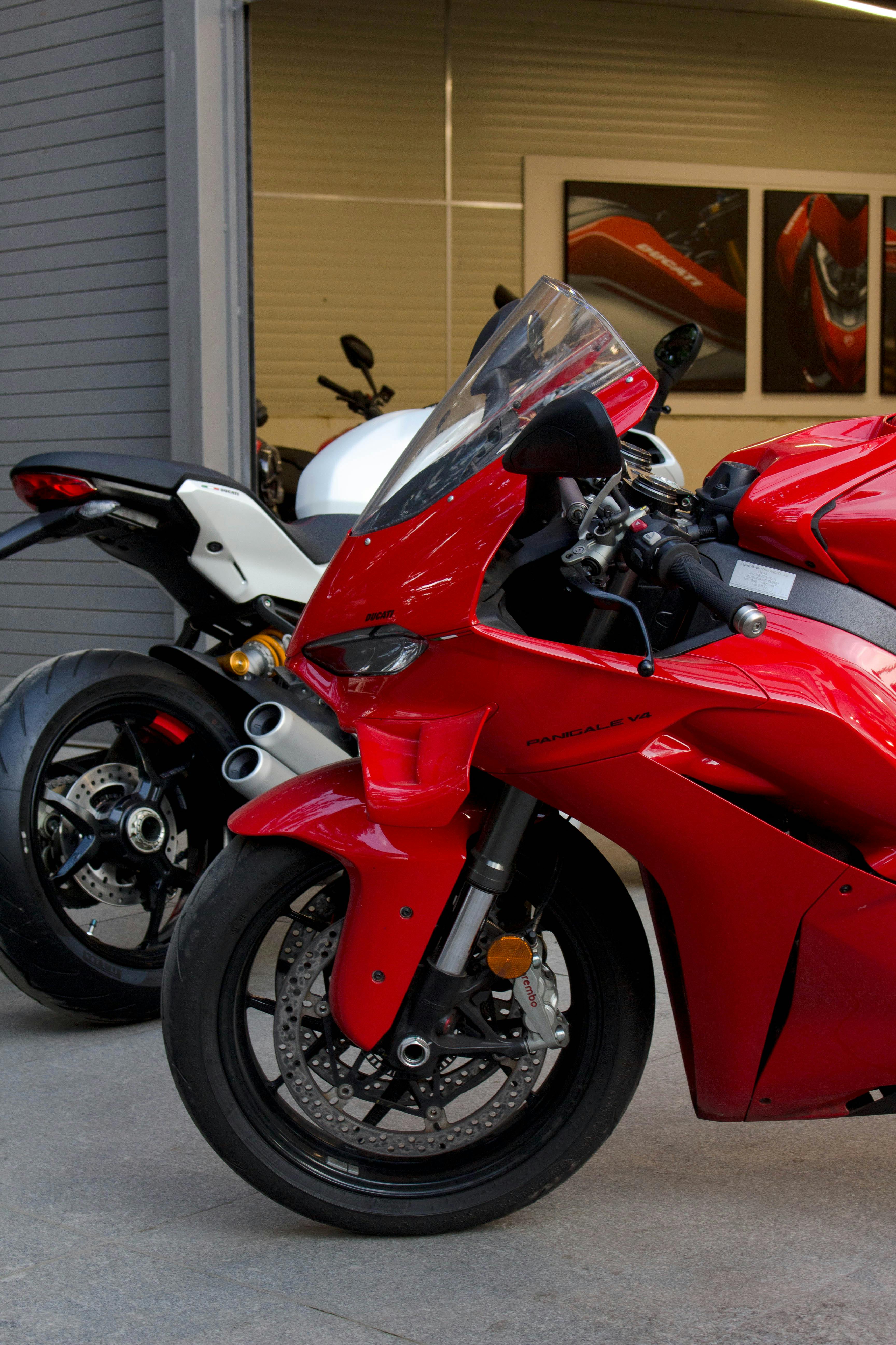 Modern Red Sports Motorcycles in Showroom · Free Stock Photo