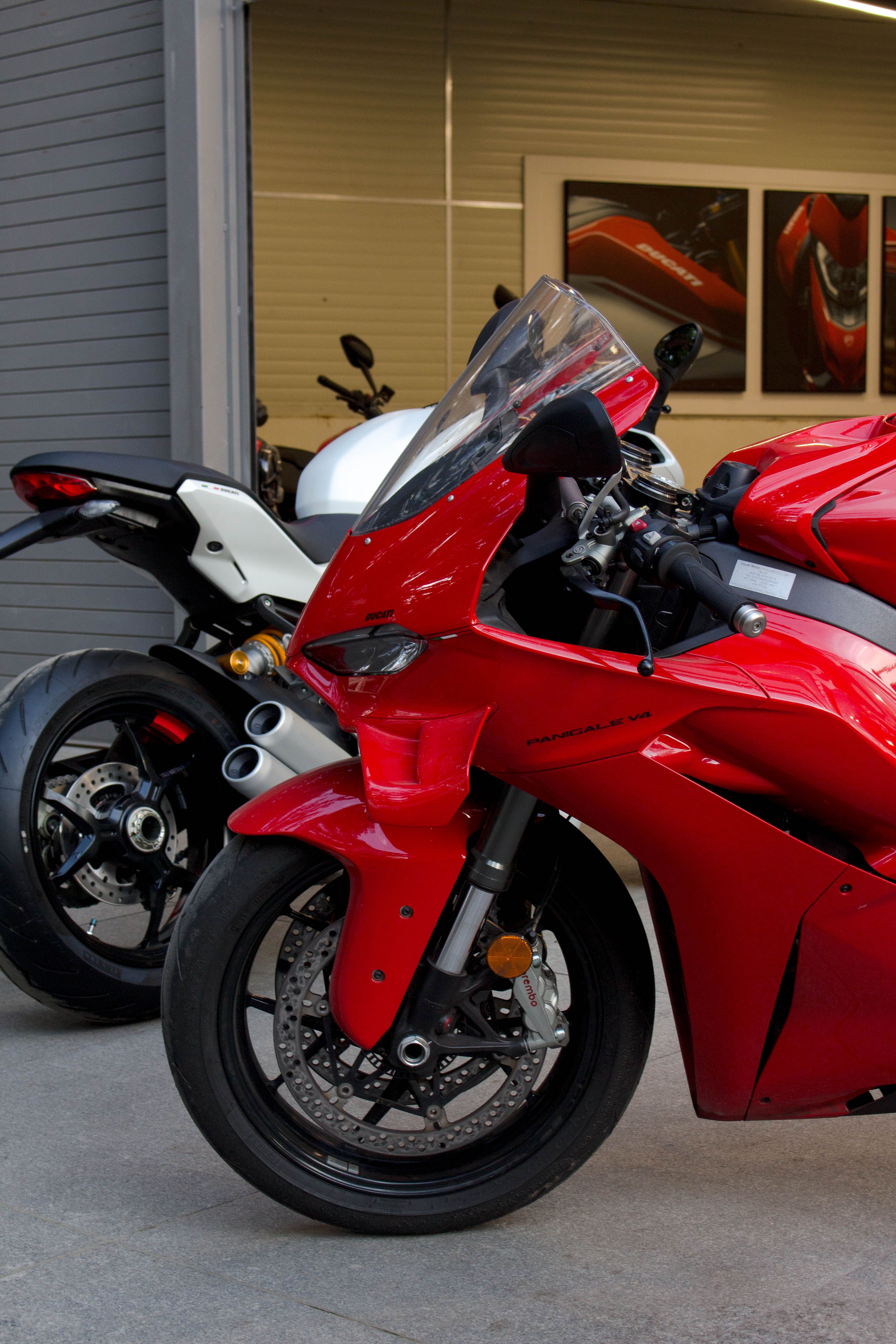 Modern Red Sports Motorcycles in Showroom · Free Stock Photo