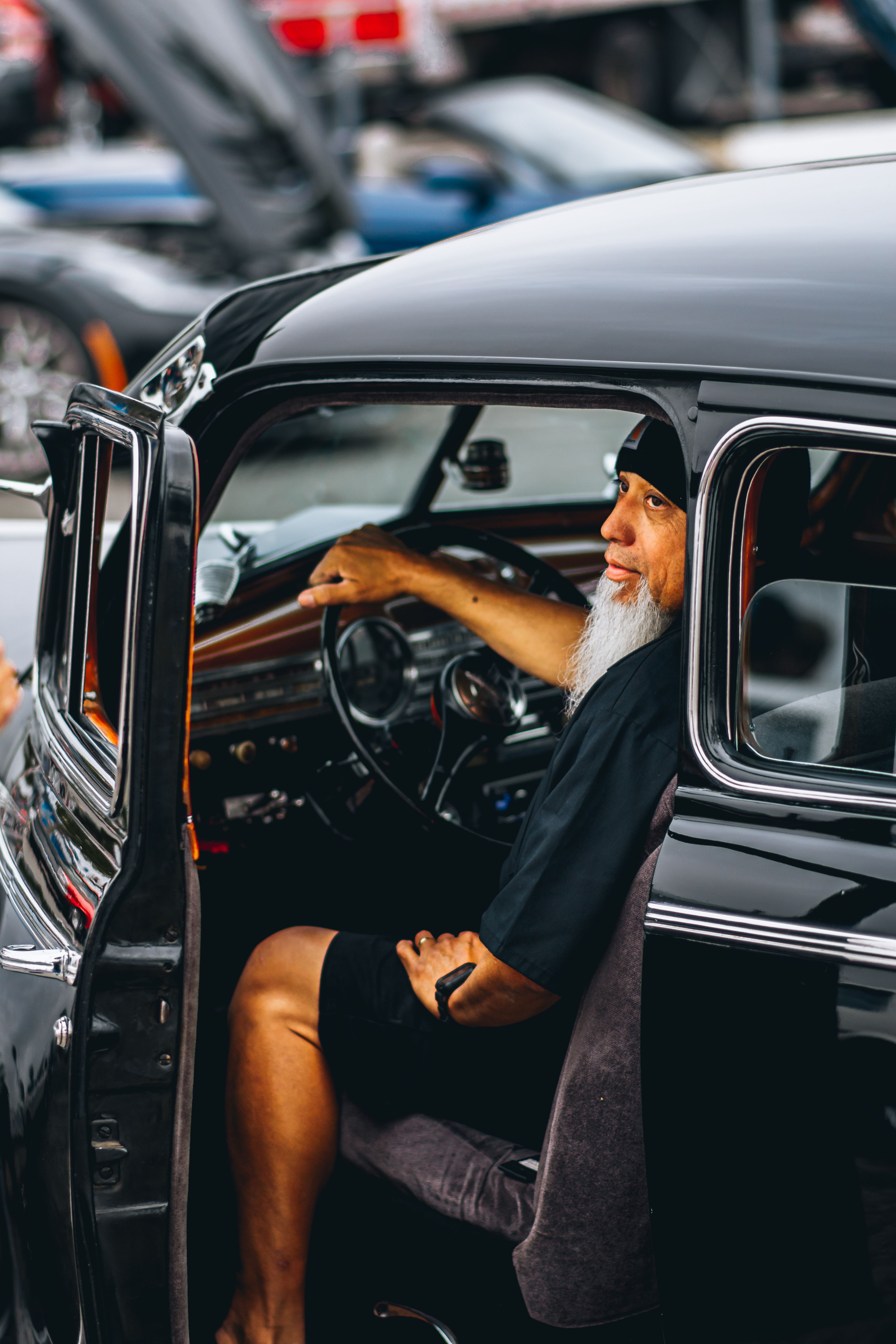 Man Driving Classic Car at Los Angeles Car Show · Free Stock Photo