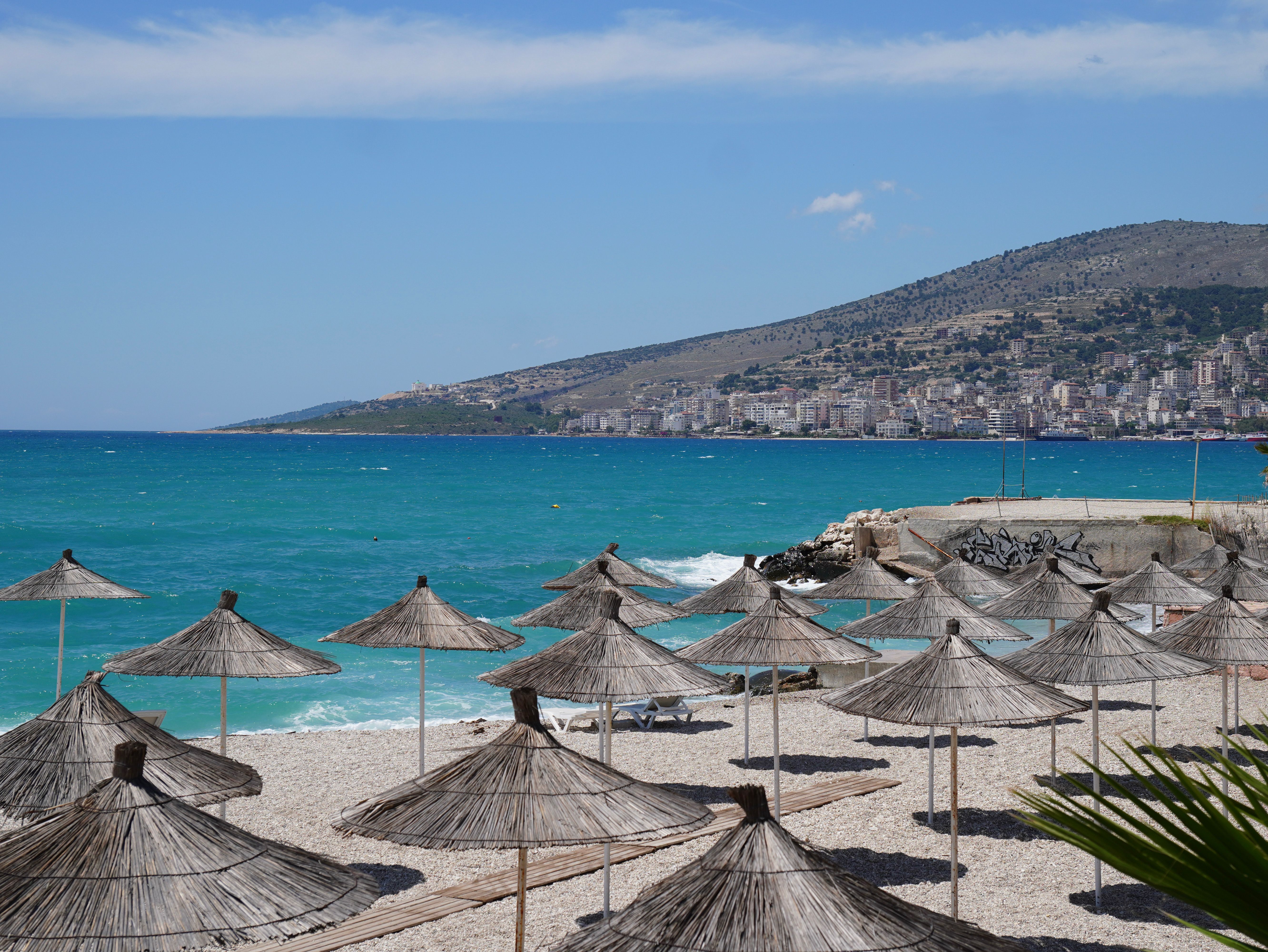 Sunny Beach with Umbrellas on Mediterranean Coast · Free Stock Photo