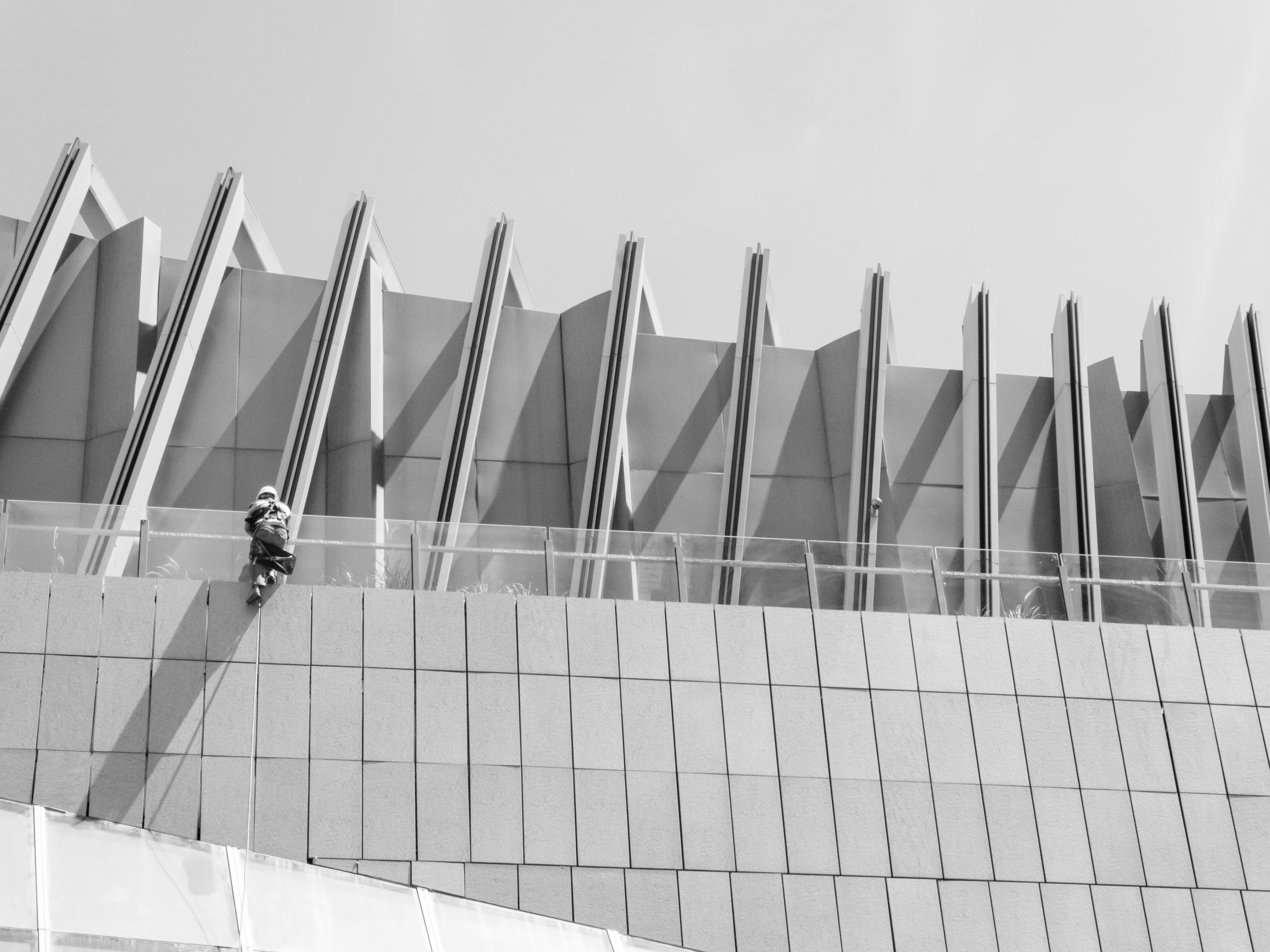 Facade Maintenance Worker on Modern Building · Free Stock Photo