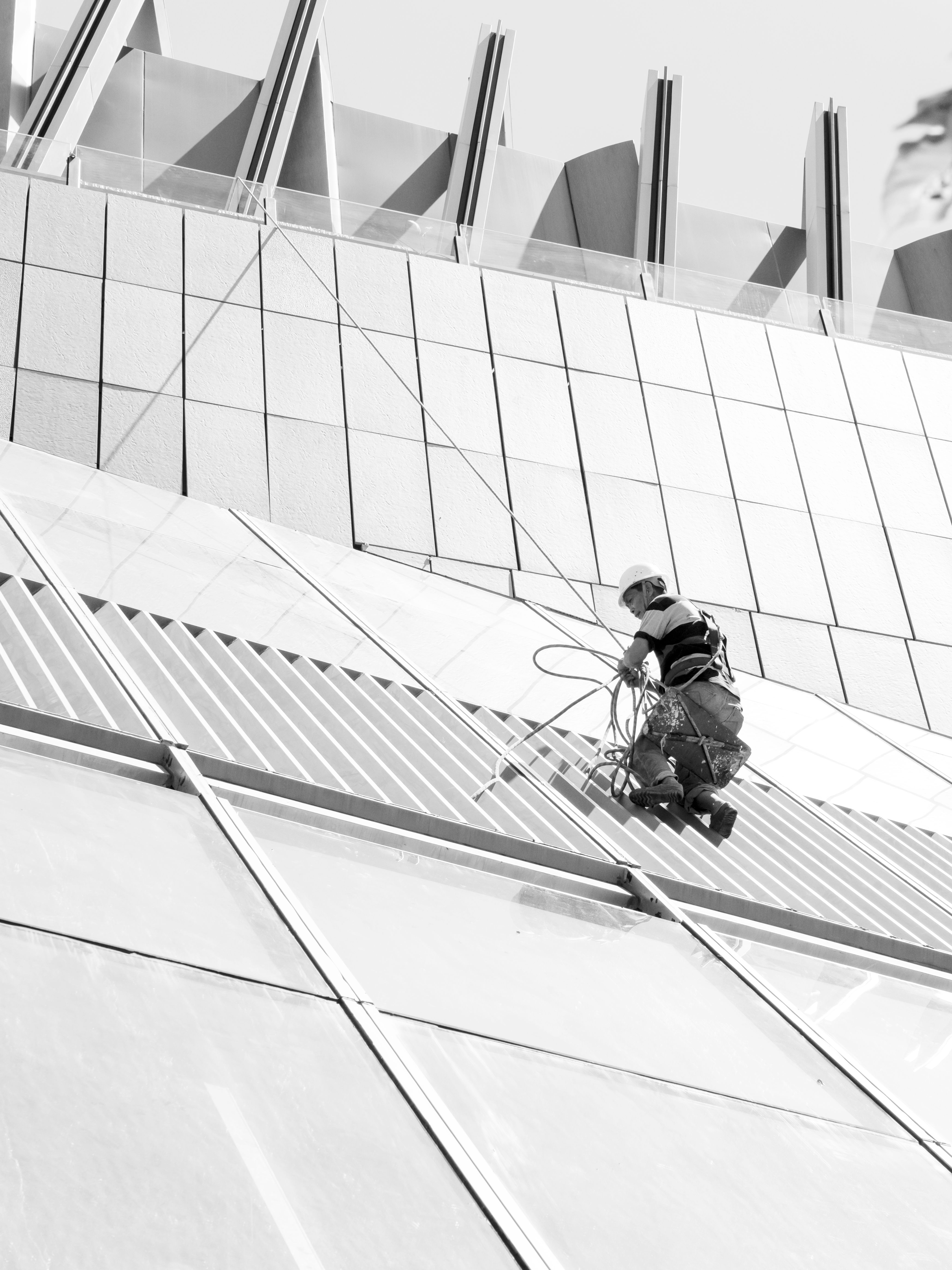 Window Cleaner on Modern Glass Building Facade · Free Stock Photo